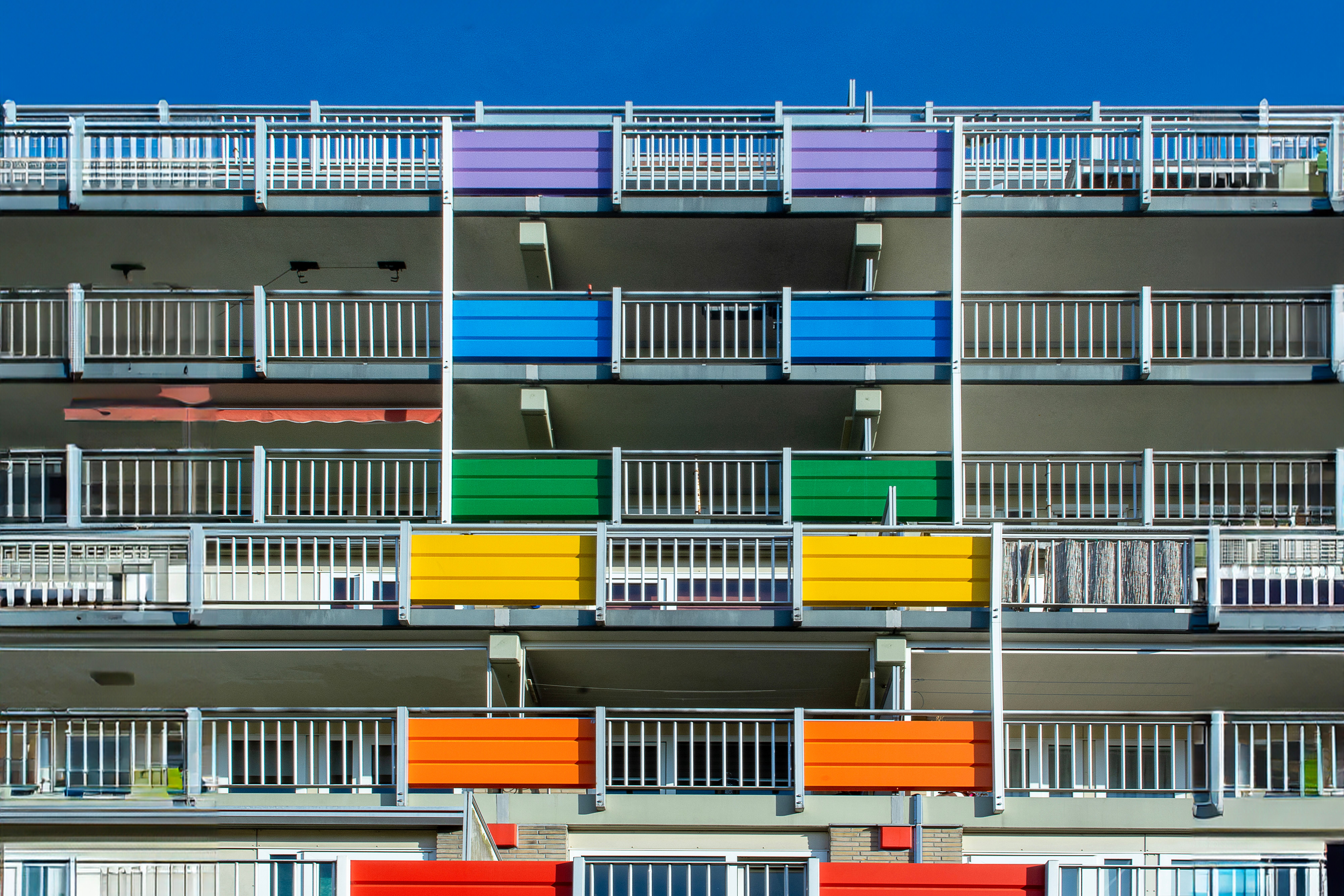Large Apartment Building with Colorful Rainbow Balconies · Free Stock Photo