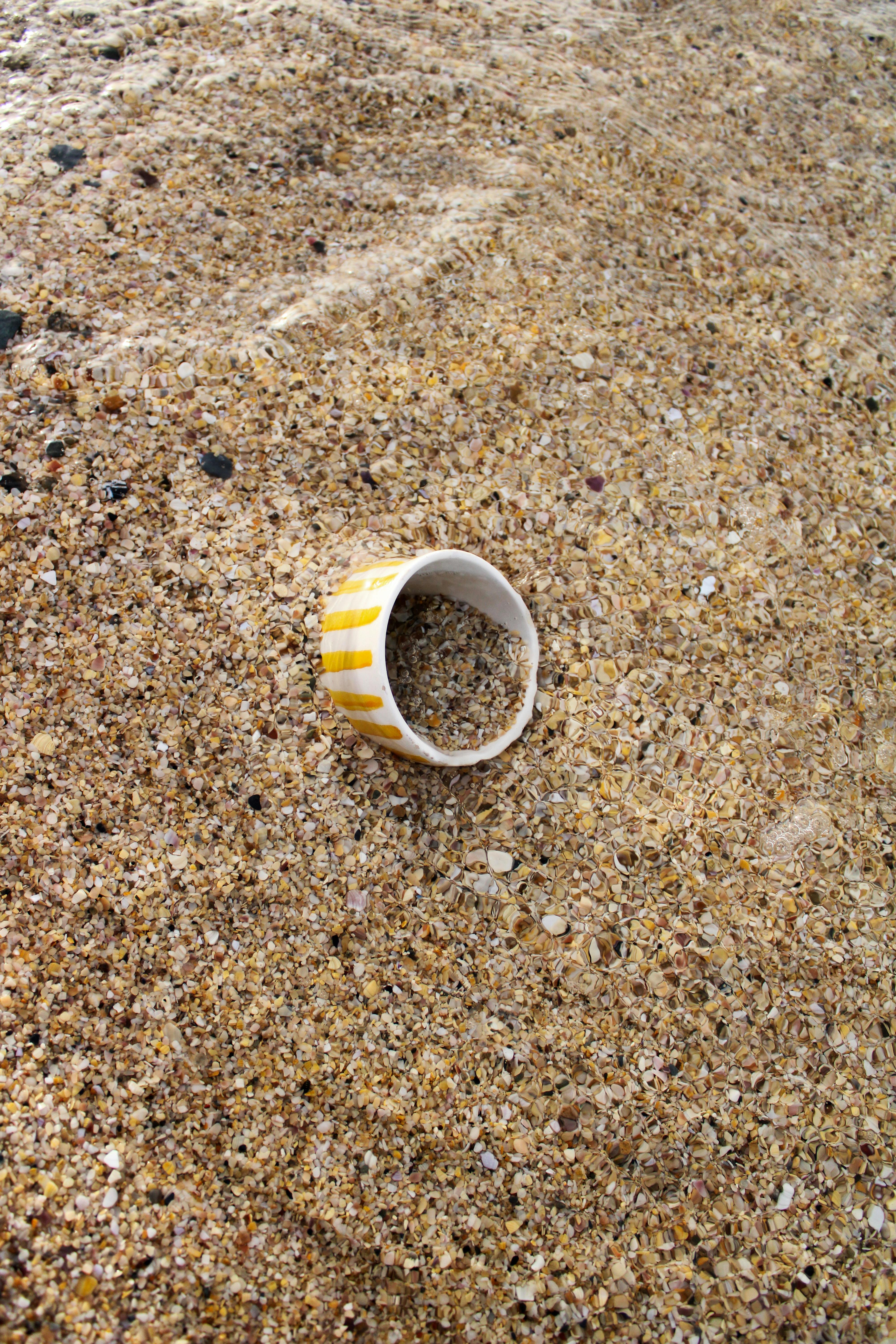 Cup in the Sand · Free Stock Photo