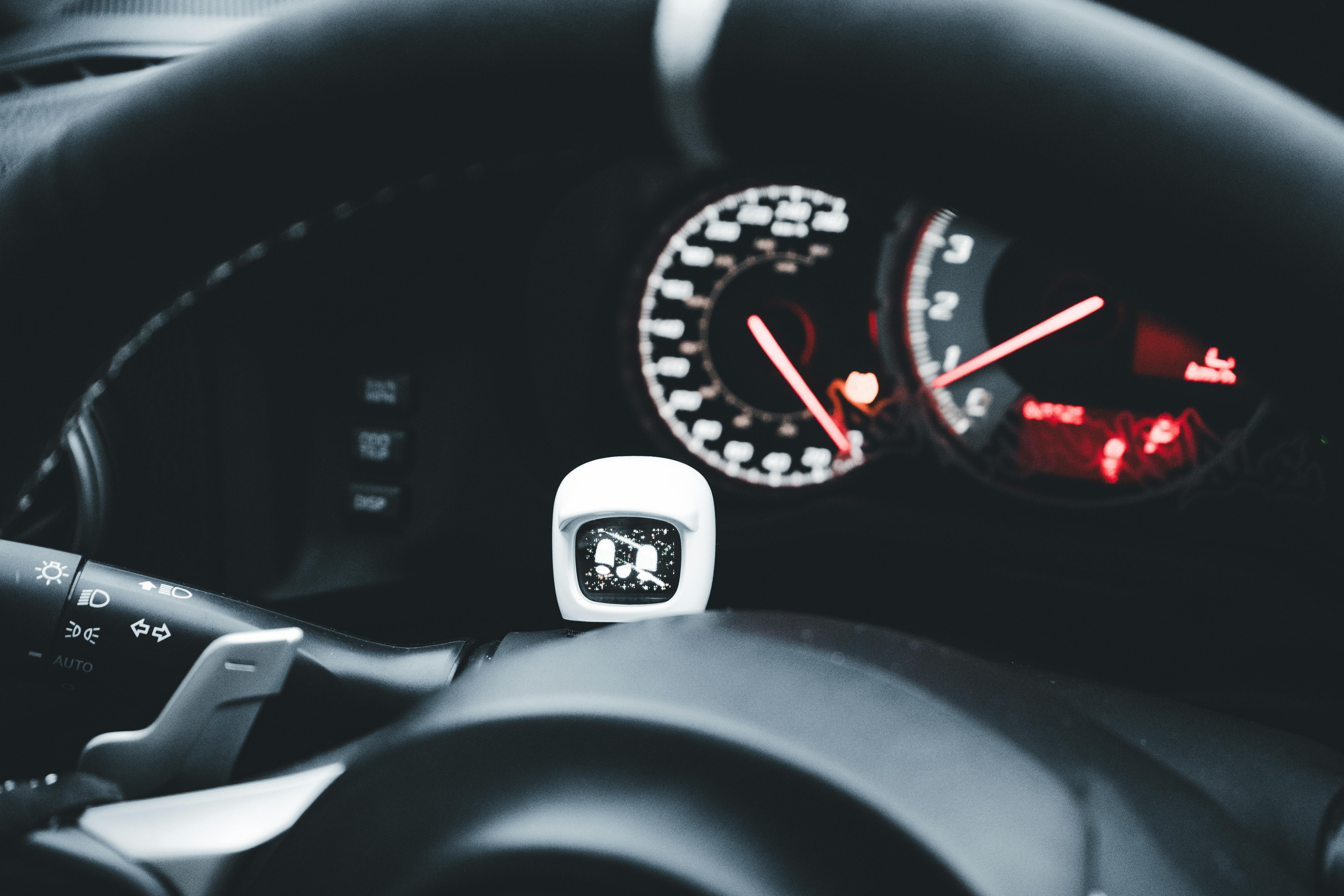 A dashboard with a speedometer and a steering wheel · Free Stock Photo