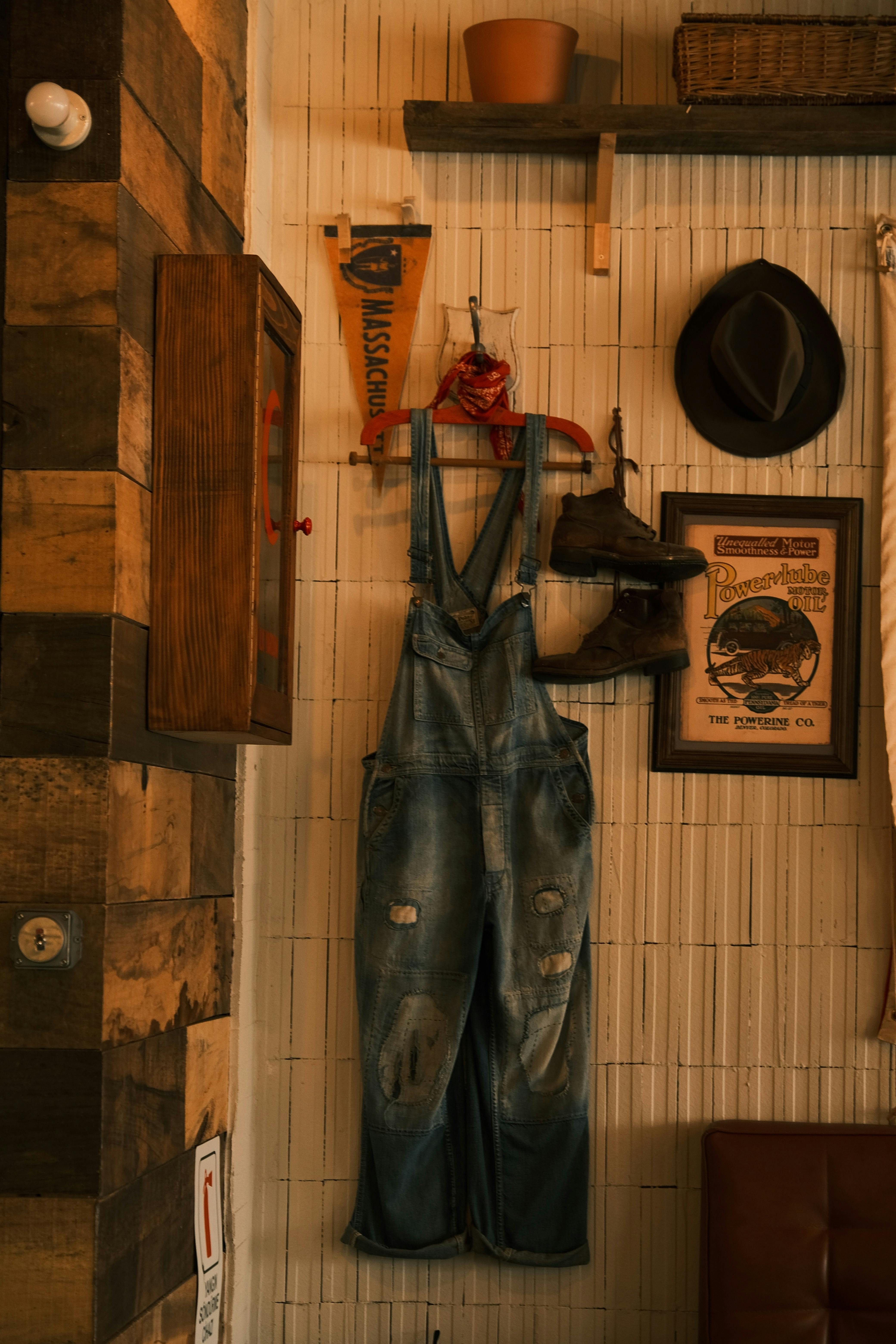 Overalls on Hanger with Shoes on Wall · Free Stock Photo