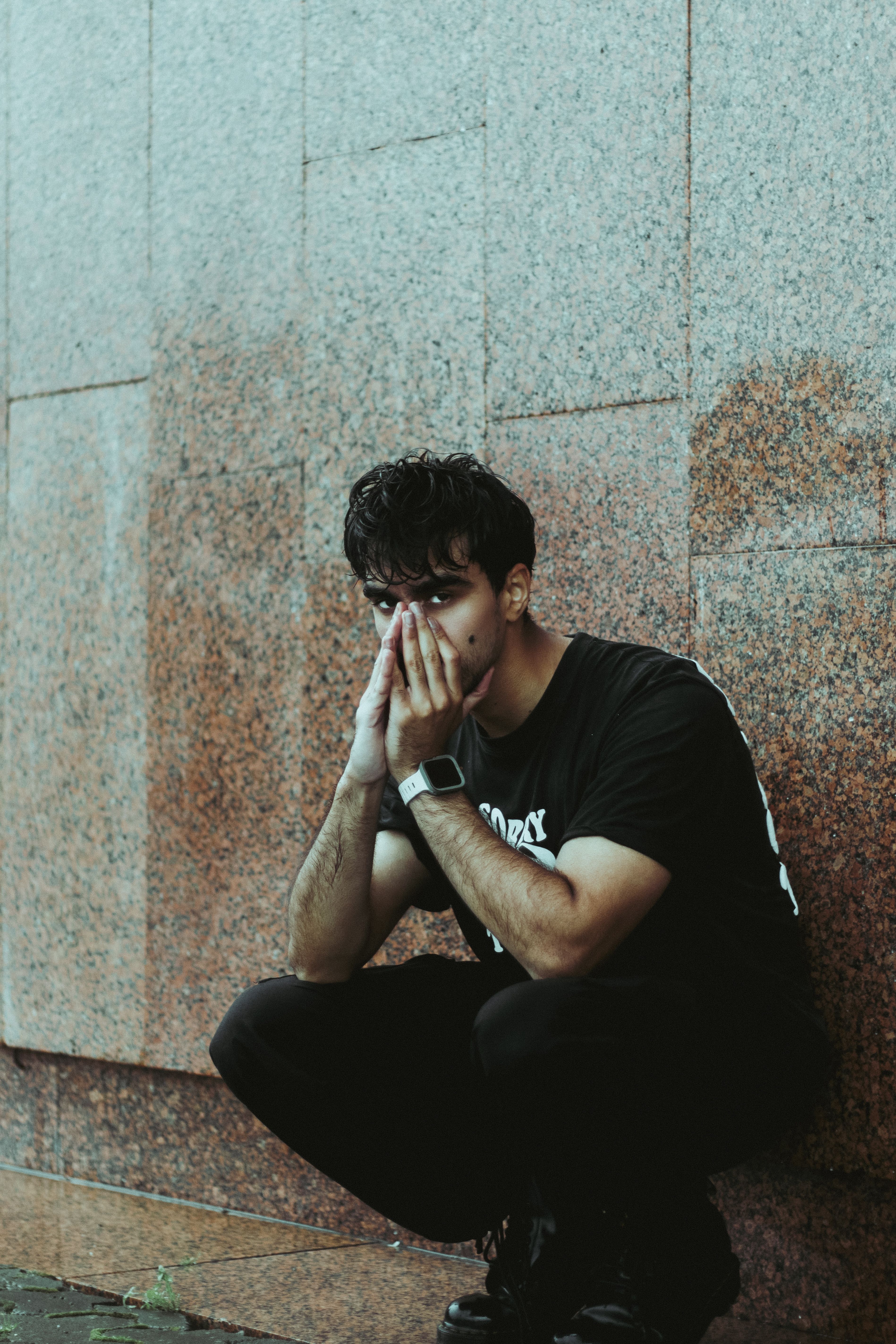 Man Sitting with Hand over Mouth · Free Stock Photo