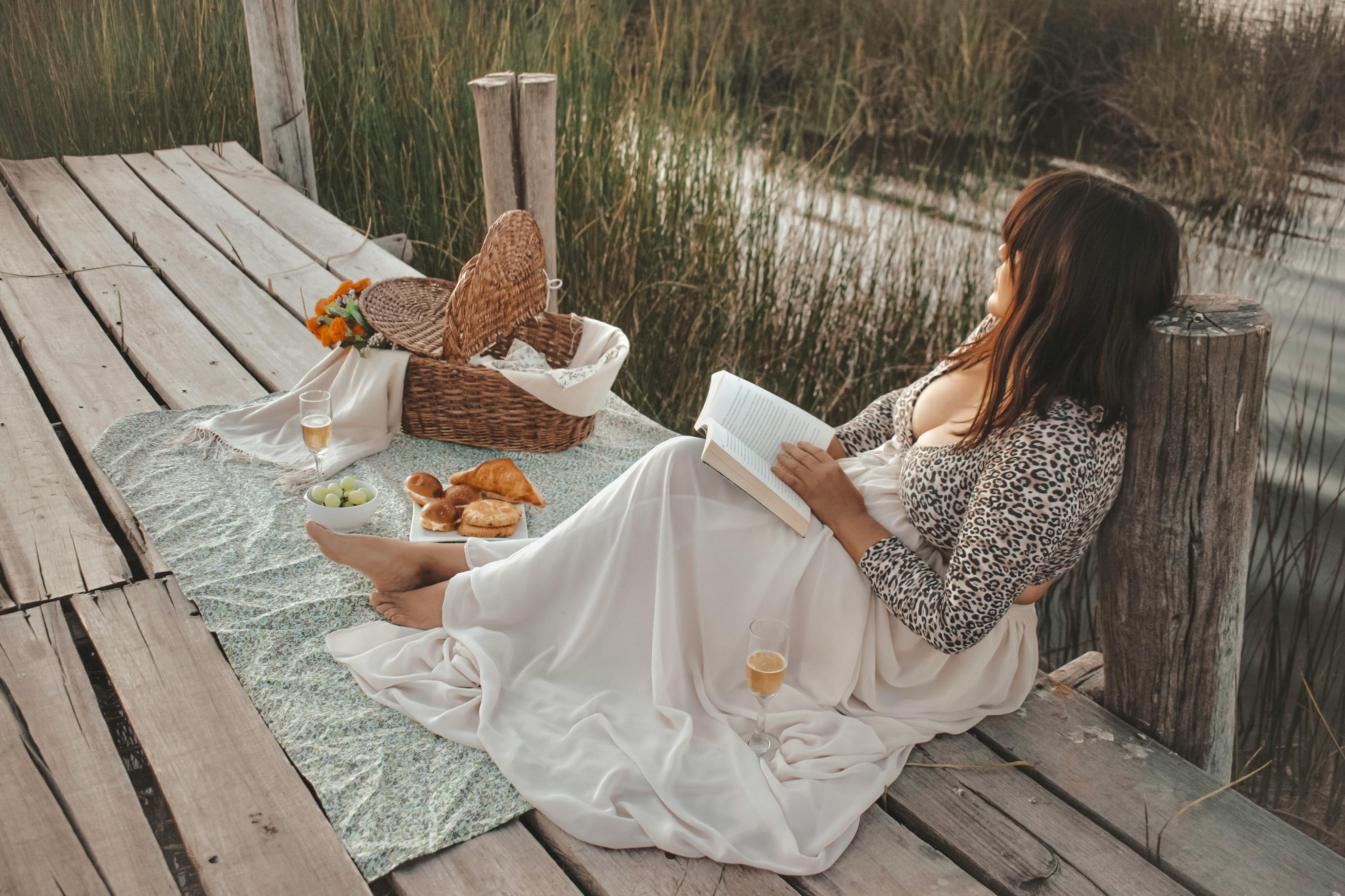 Girl Sitting On the Pier with a Book · Free Stock Photo