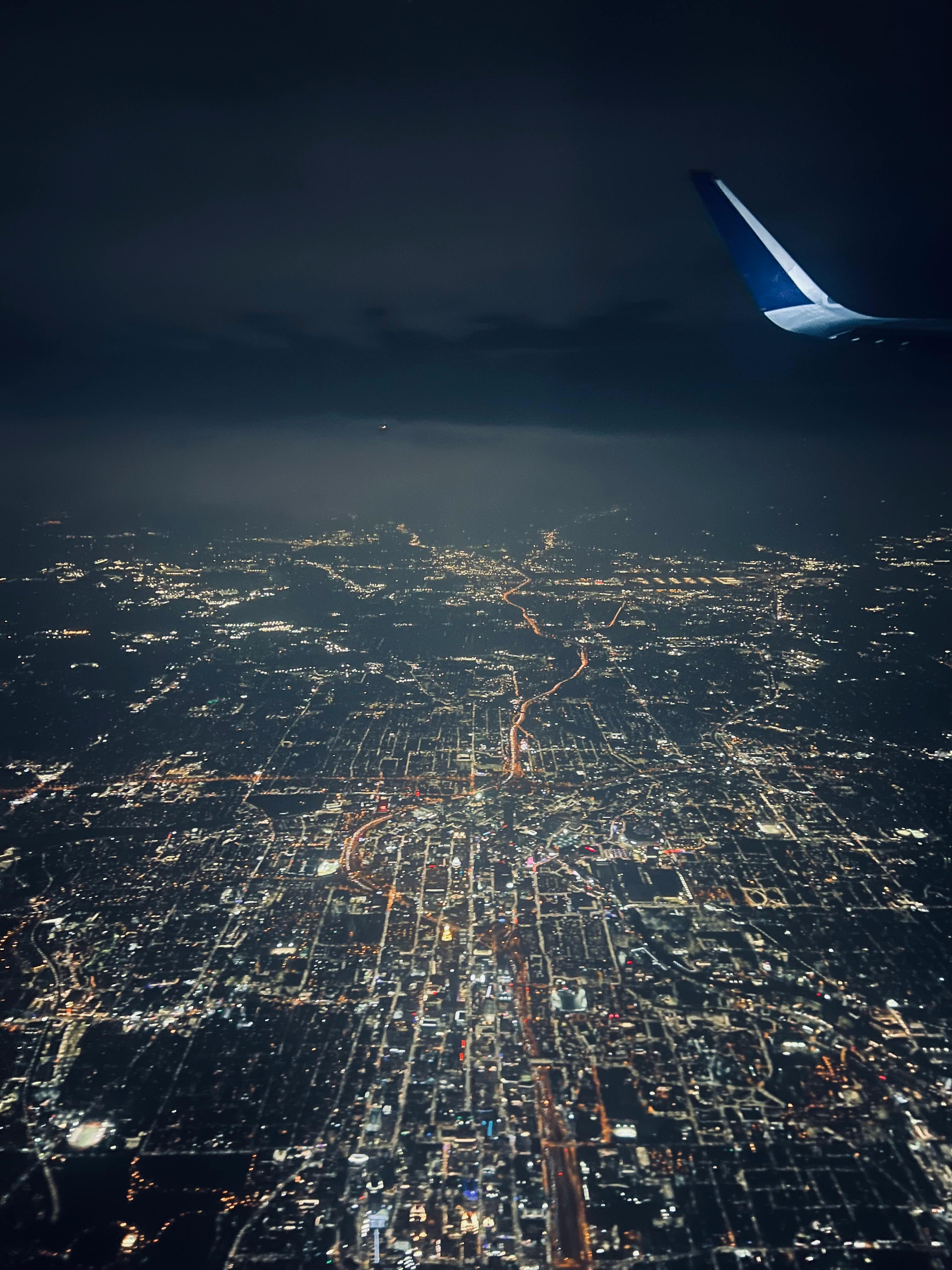 City Lights under Flying Airplane at Night · Free Stock Photo