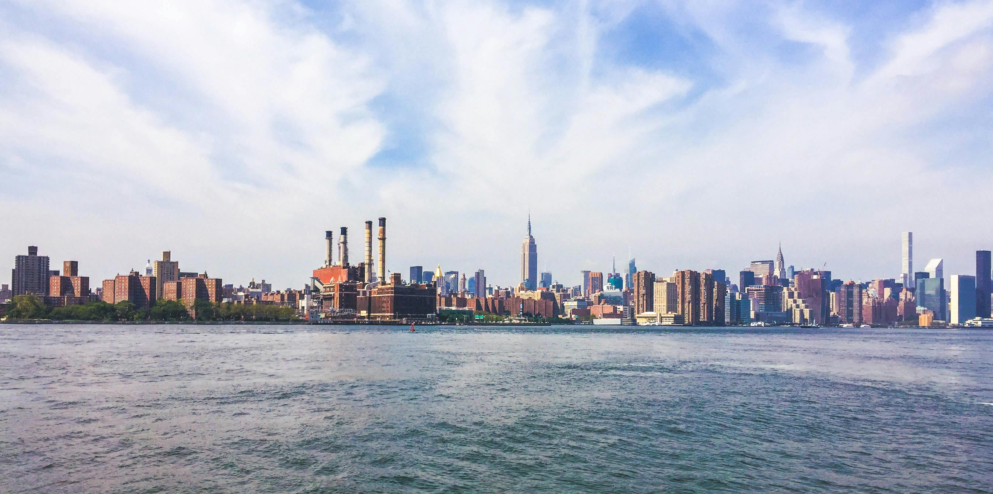 Modern megapolis at river shore with skyscrapers · Free Stock Photo