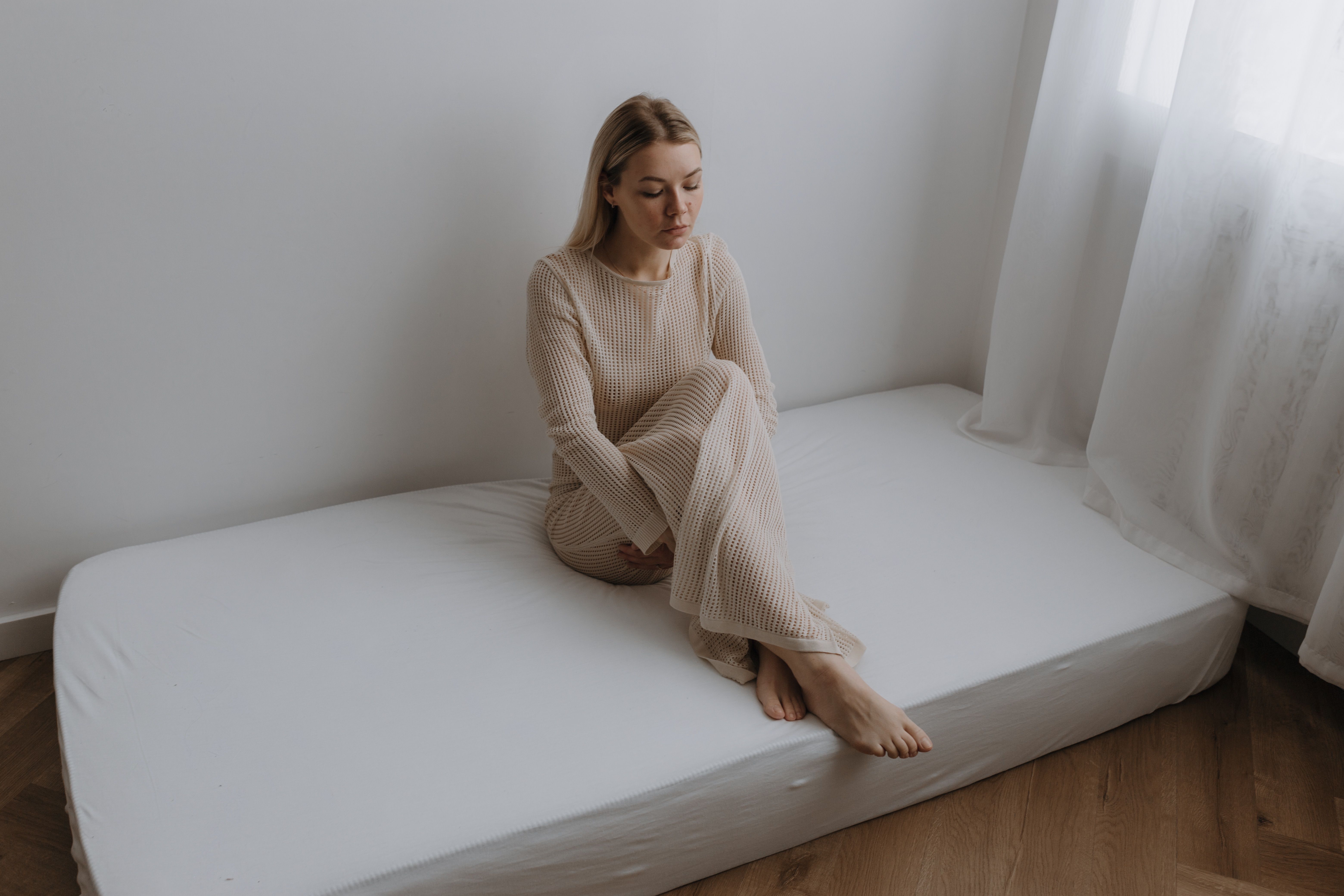 Sitting on Mattress Woman in White Mesh Dress · Free Stock Photo