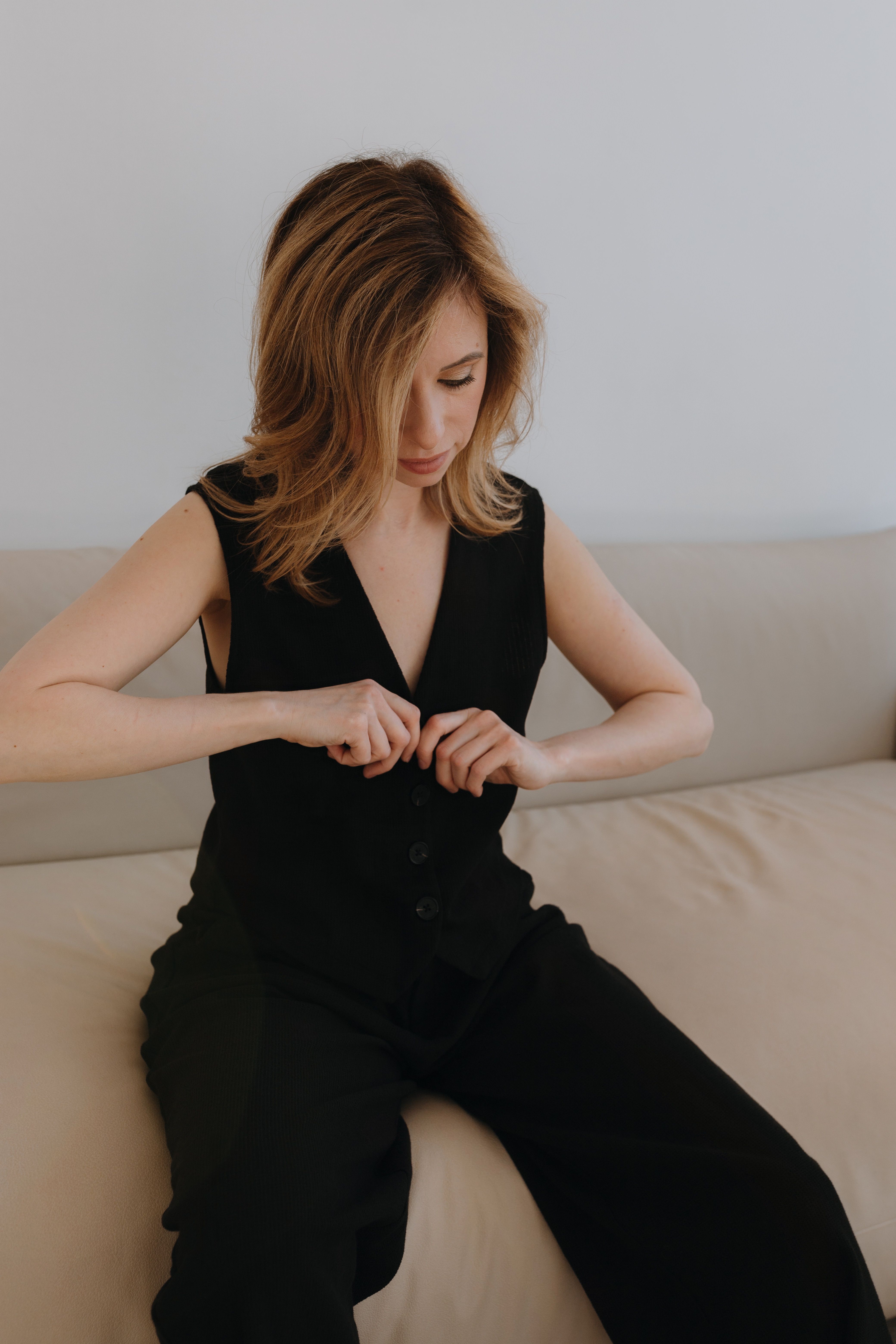 Woman in Tank Top Sitting on Couch · Free Stock Photo