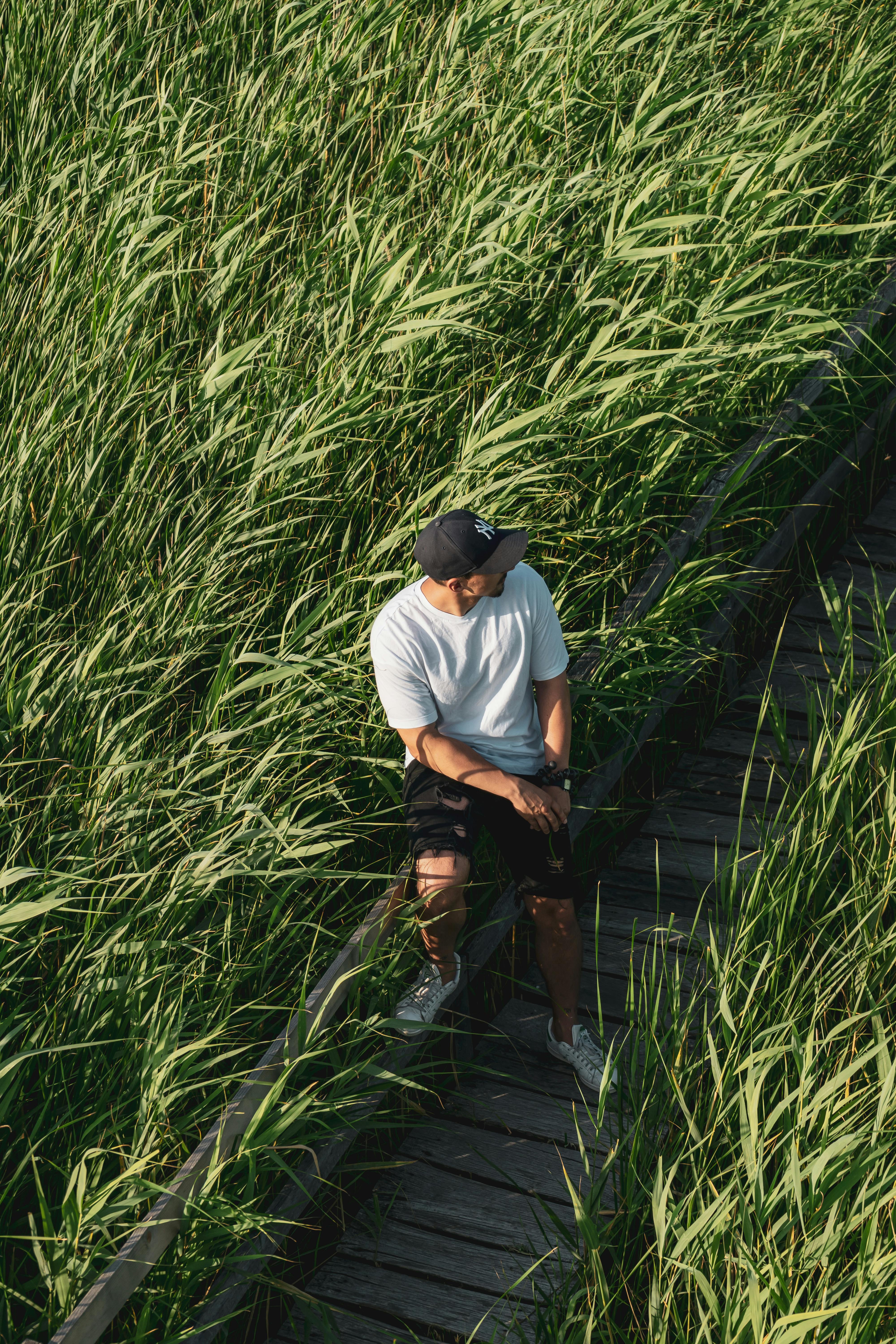 High Angle Photography of a Man Sitting on a Bridge · Free Stock Photo