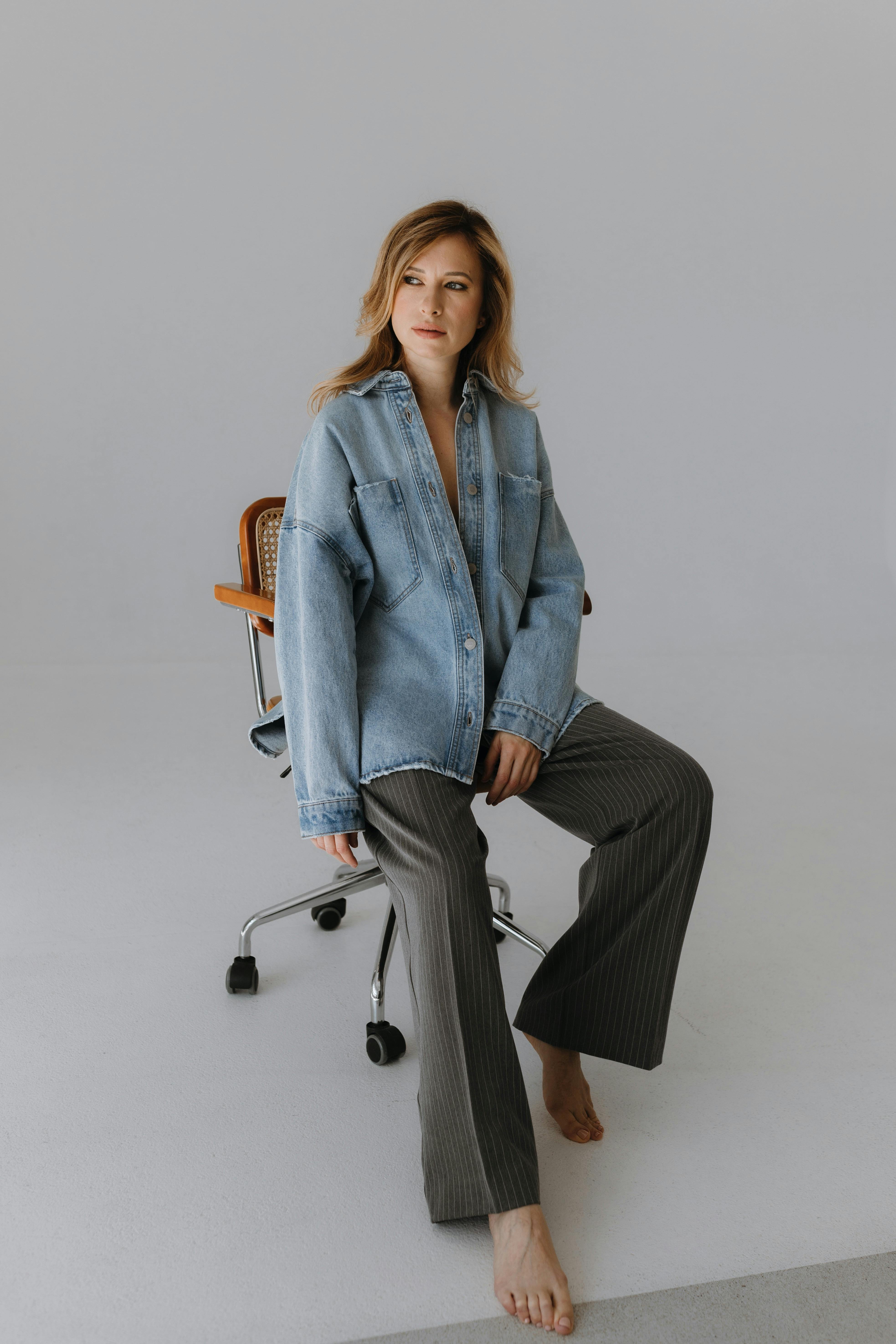 Woman in Jean Jacket on Chair · Free Stock Photo