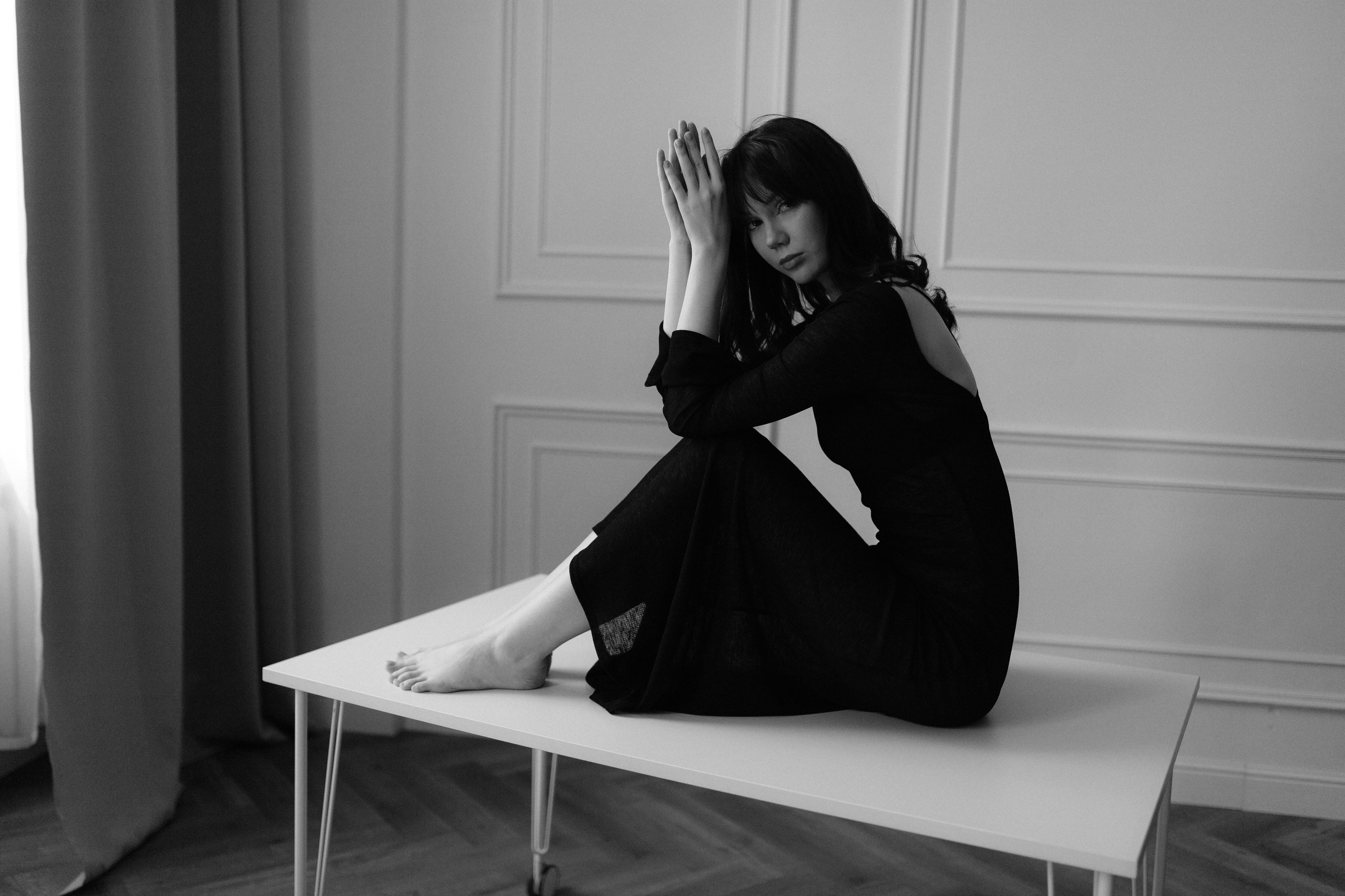 Woman in Dress Sitting on Table · Free Stock Photo