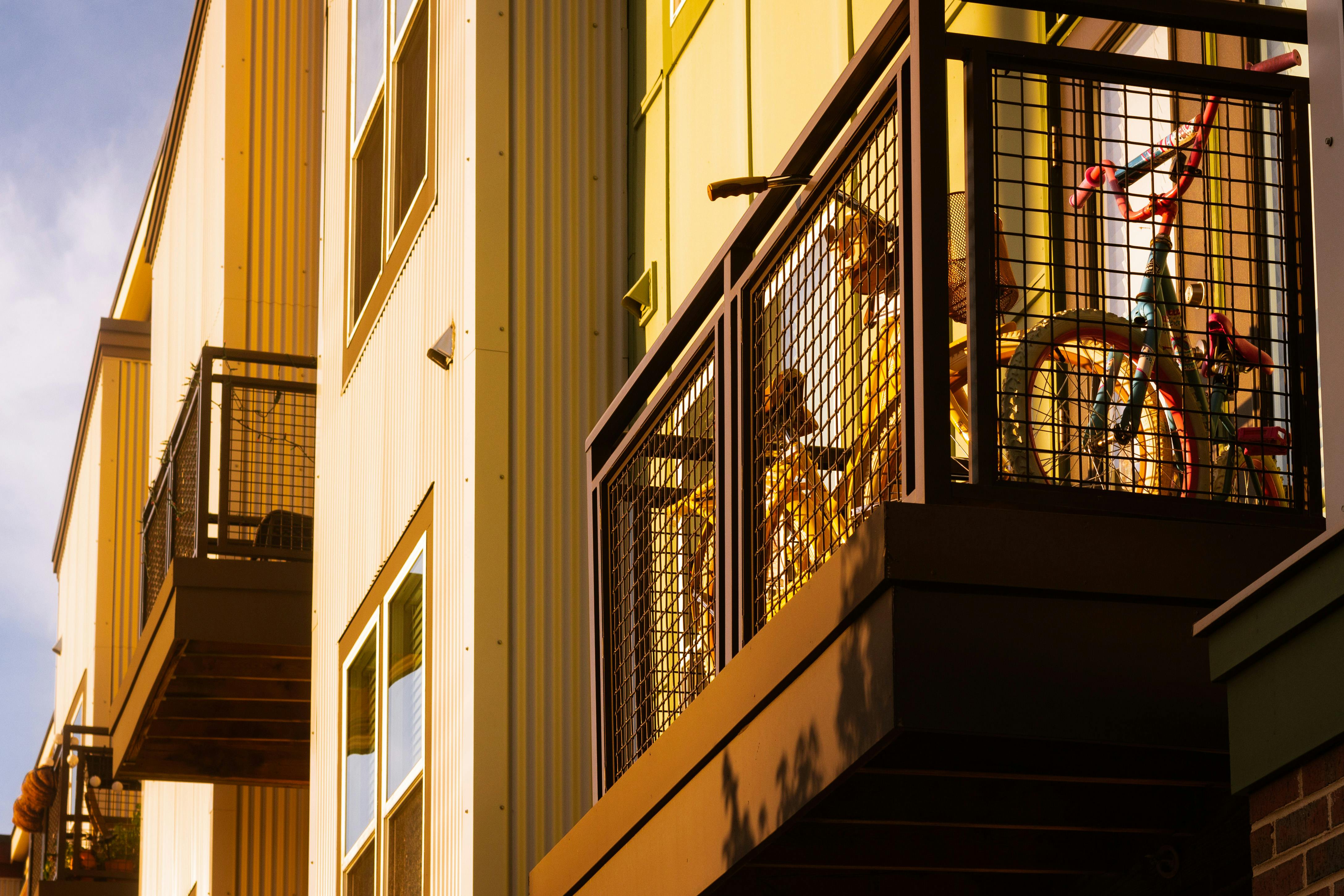 Photo of Bicycles Parked on the Balcony of a Building · Free Stock Photo