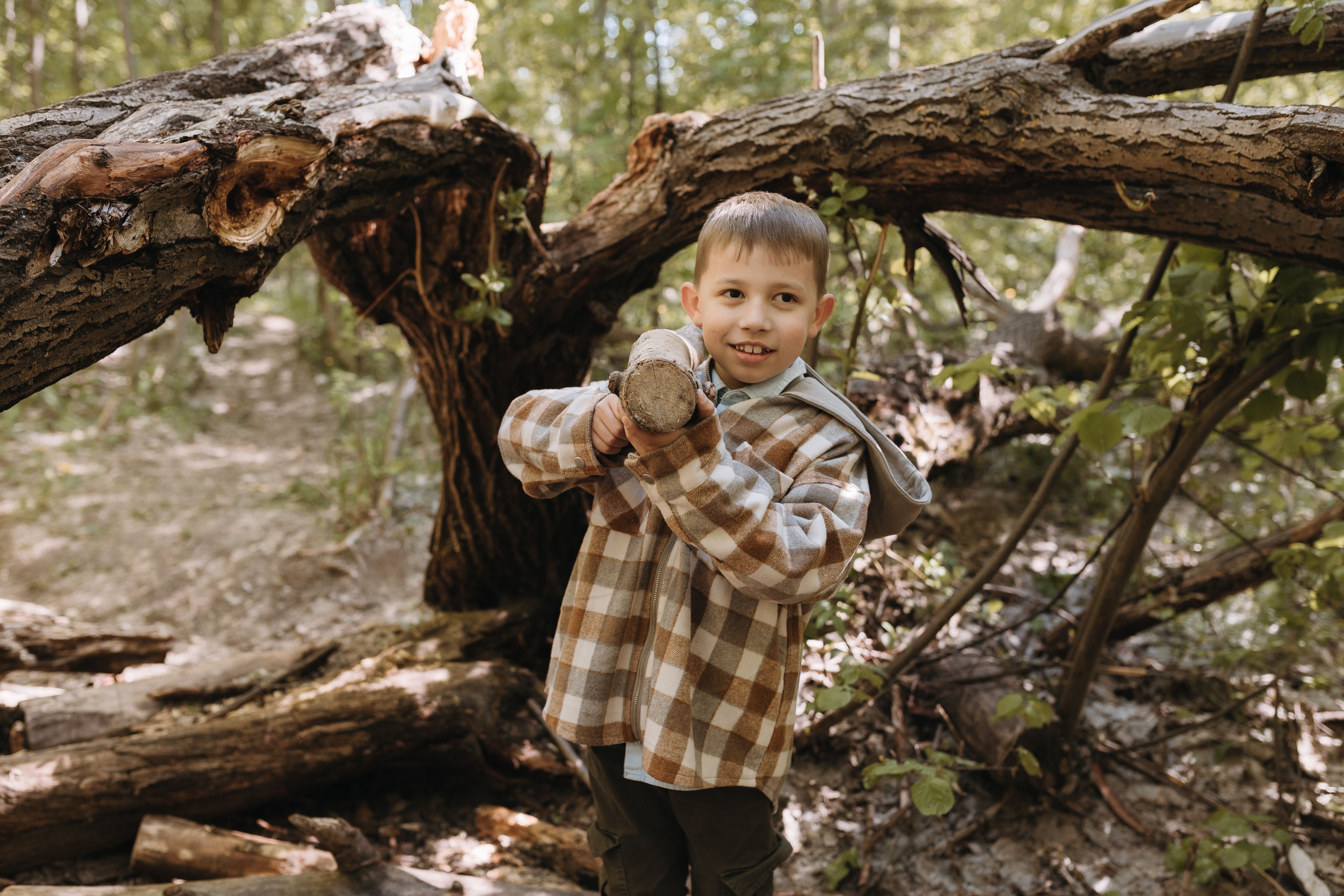 A Little Boy Standing by the Tree in the Park · Free Stock Photo