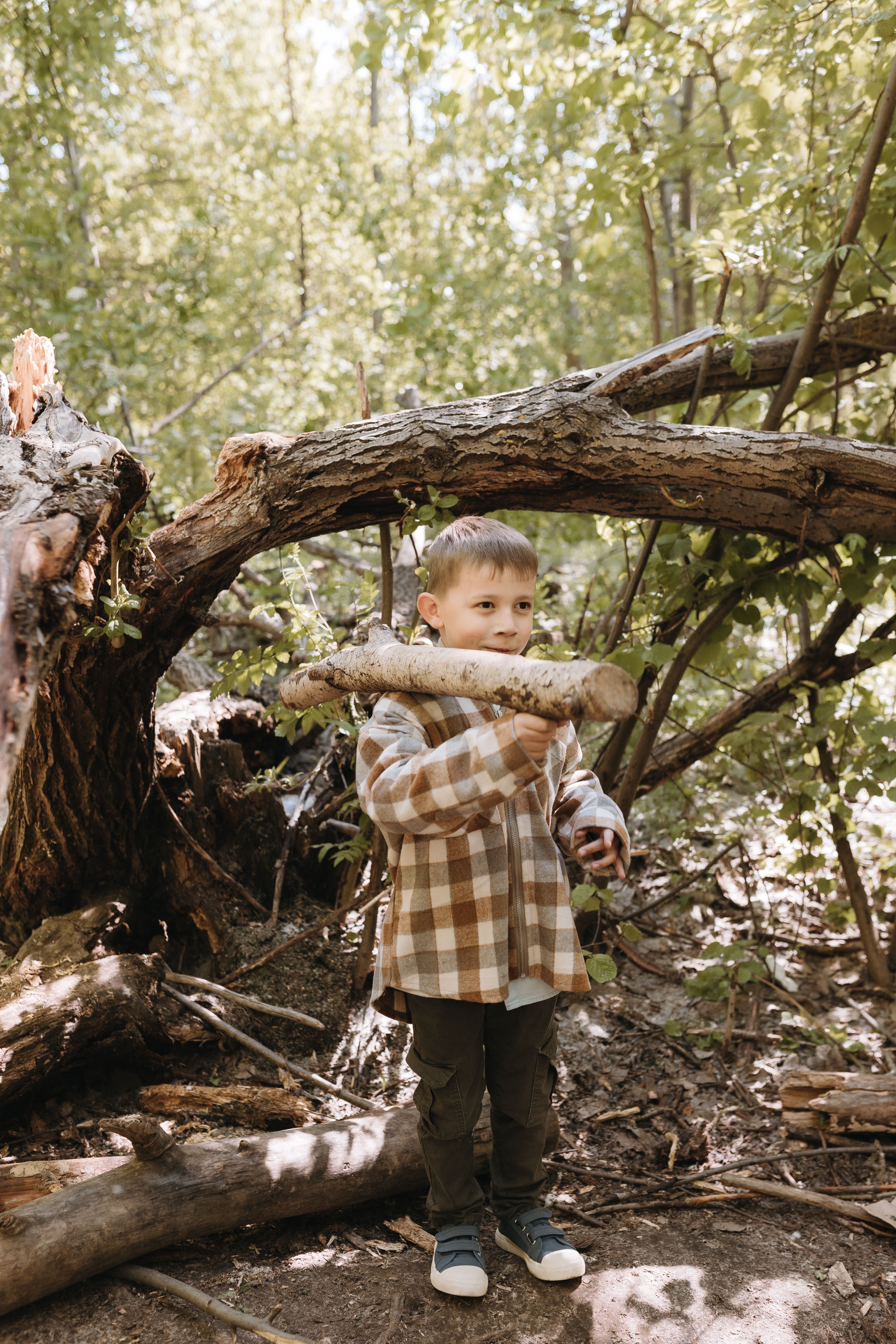 A Little Boy Standing by the Tree in the Park · Free Stock Photo