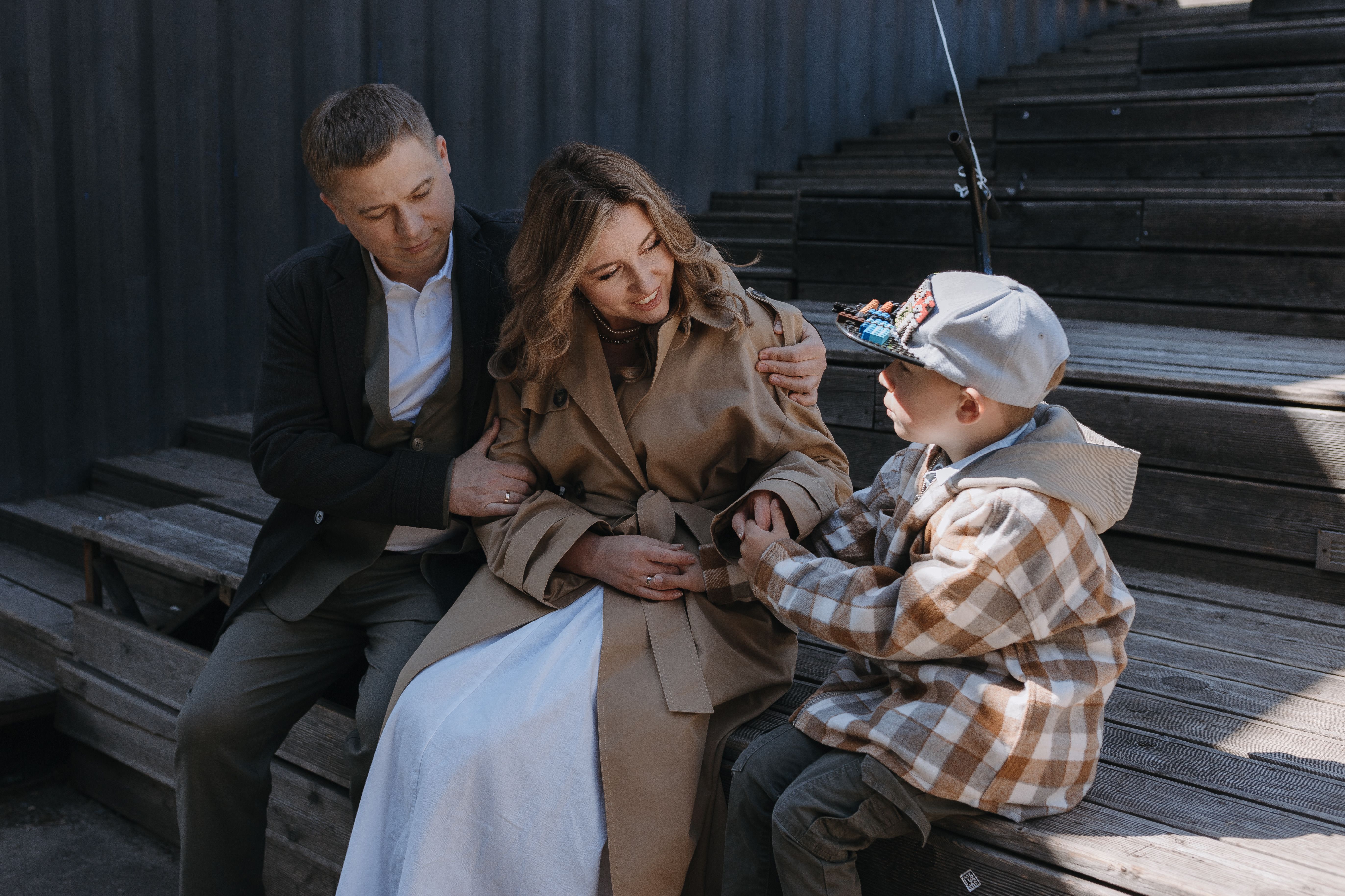 A Family with a Little Son Sitting on the Steps · Free Stock Photo