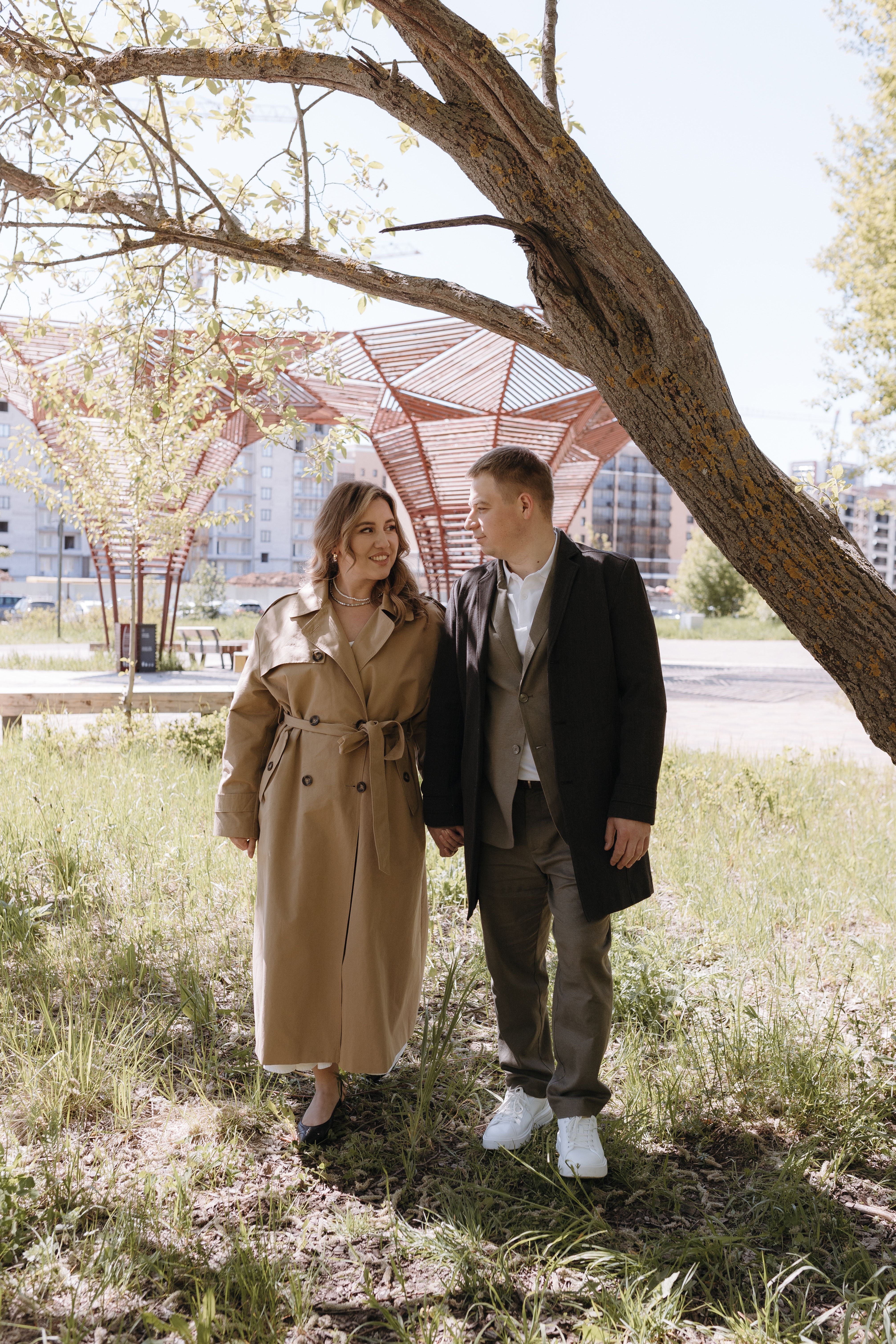 Smiling Couple in Coat and Jacket at Park · Free Stock Photo