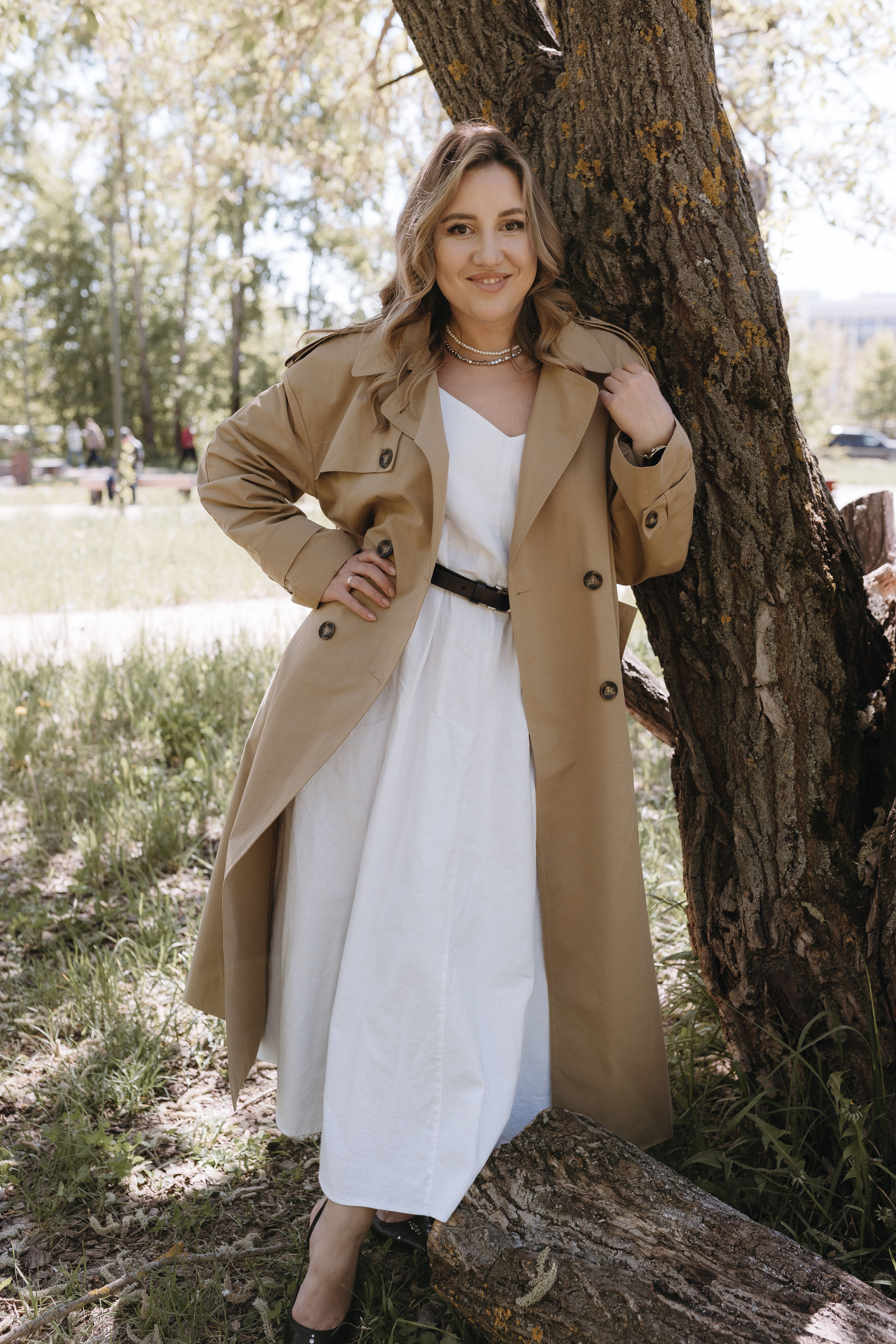 An Elegant Woman Wearing a Trench Standing in the Park · Free Stock Photo