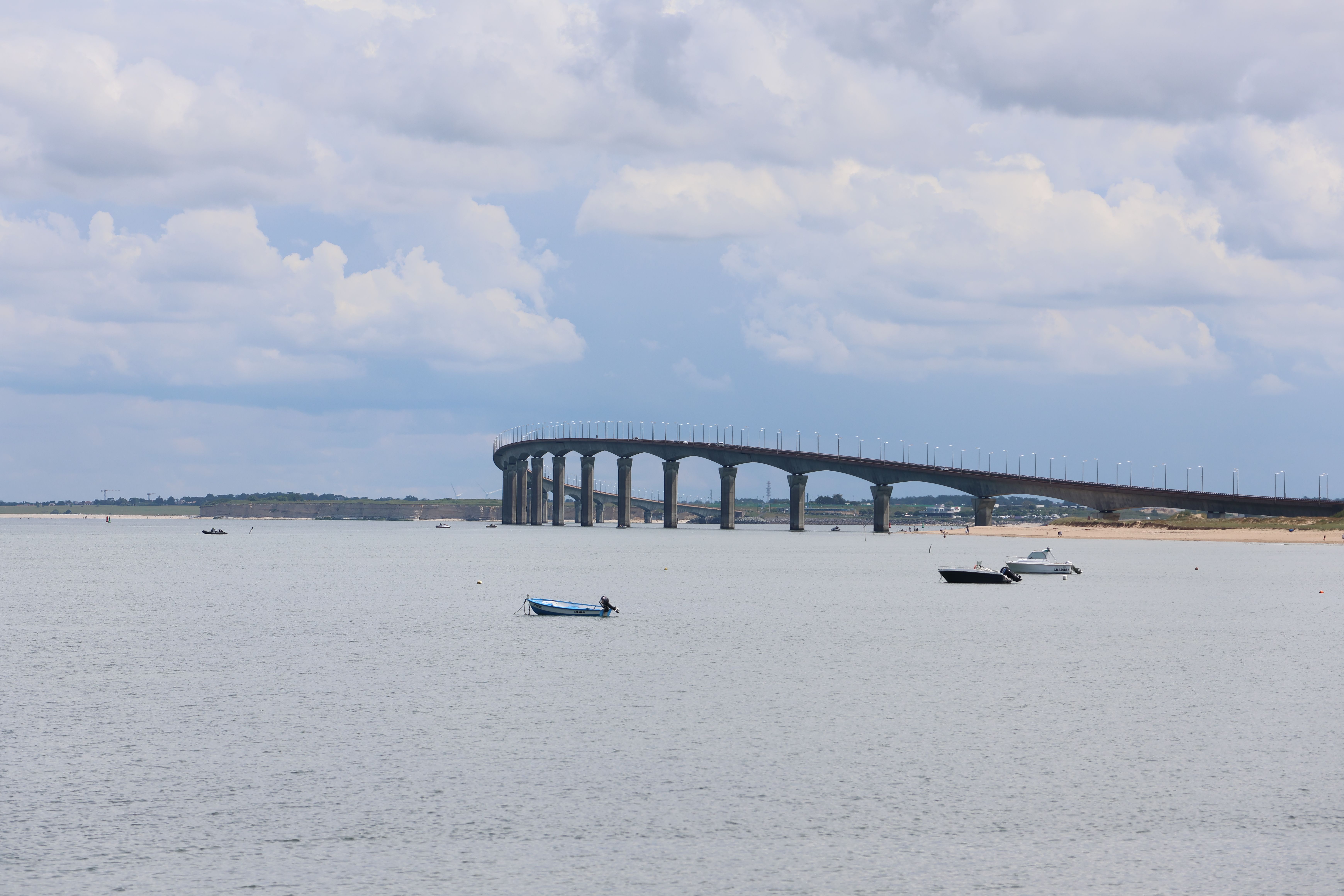 A bridge over the water with boats in the water · Free Stock Photo
