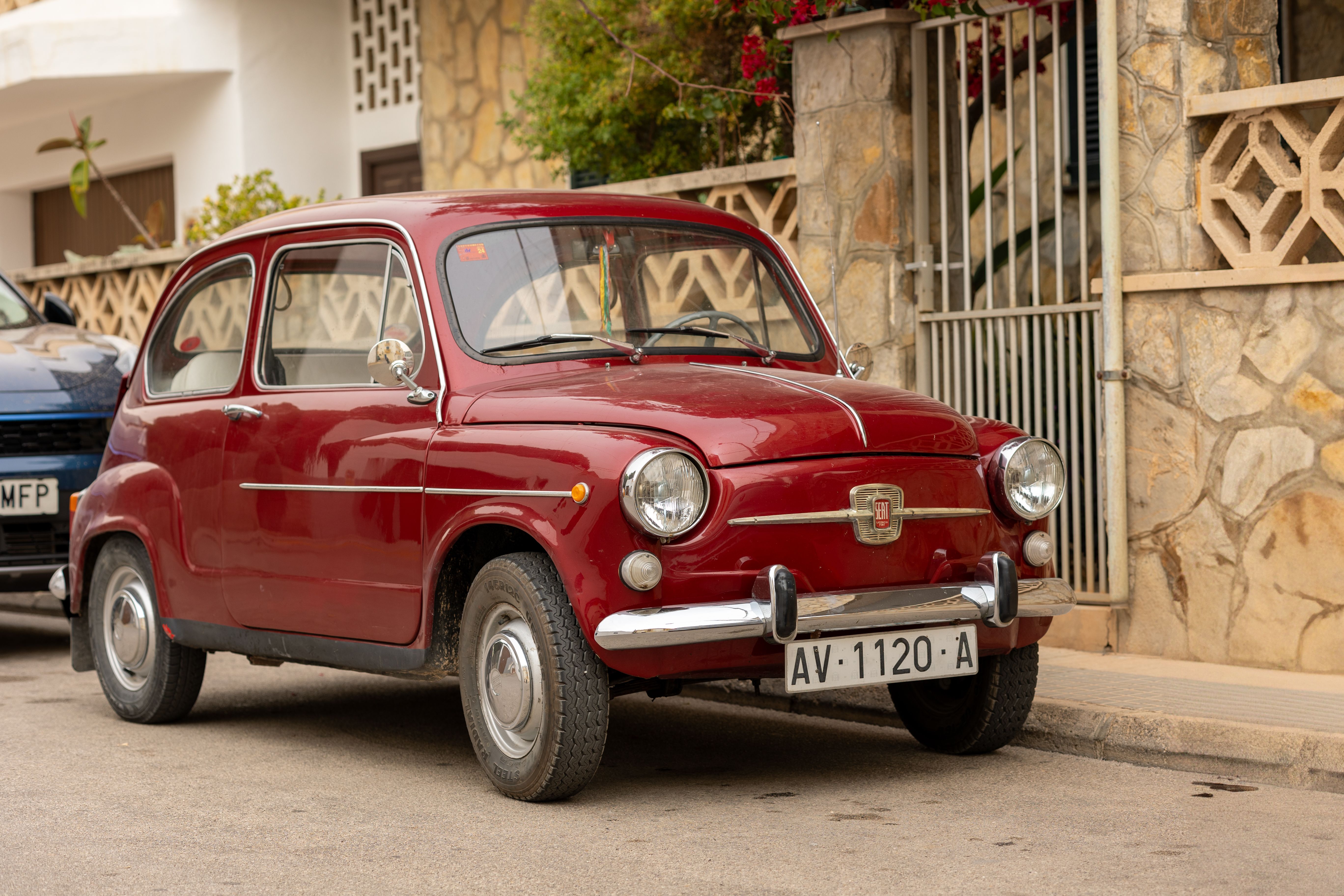 A small red car parked on the street · Free Stock Photo