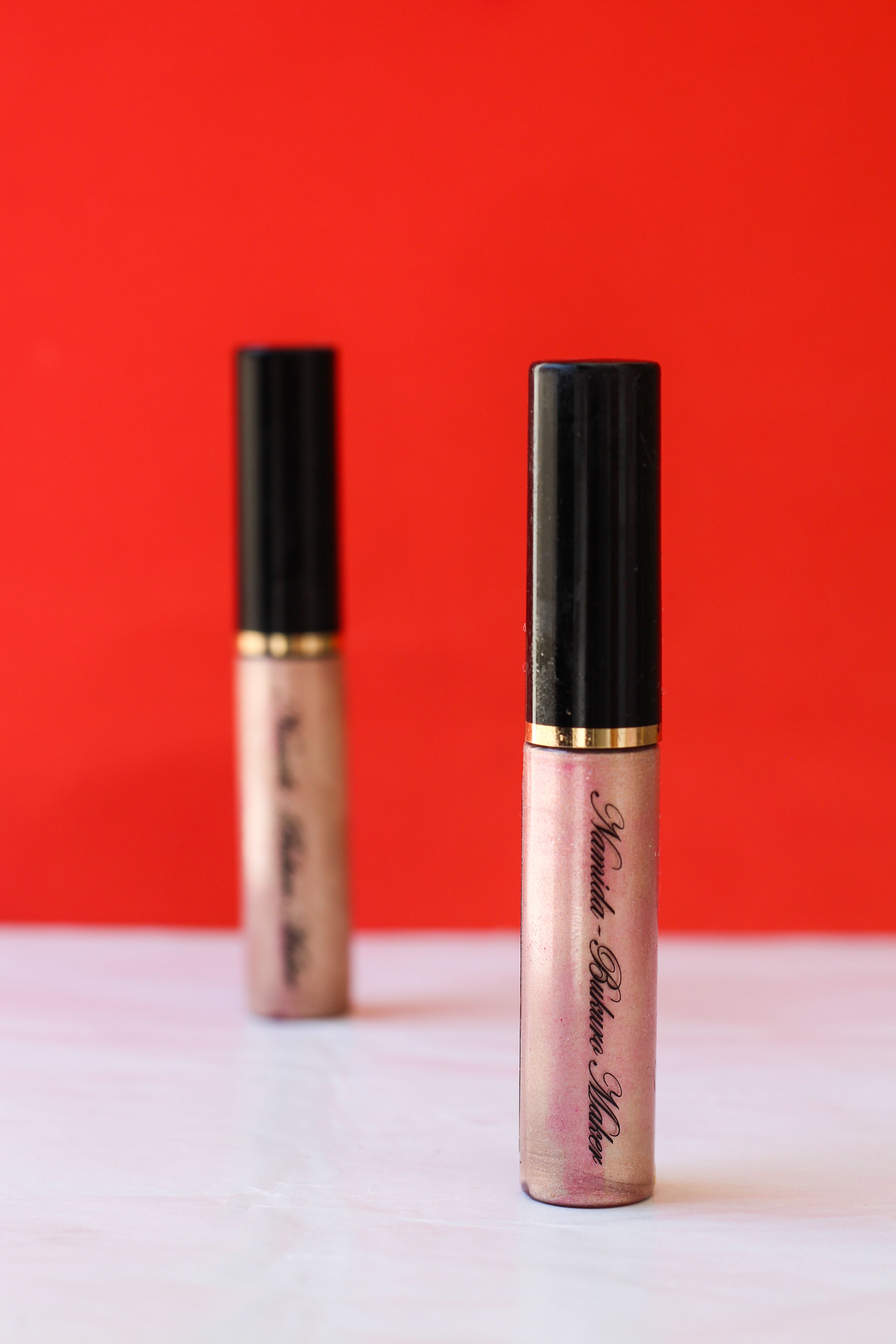 Bottles of Liquid Eyeshadow against a Red Background · Free Stock Photo