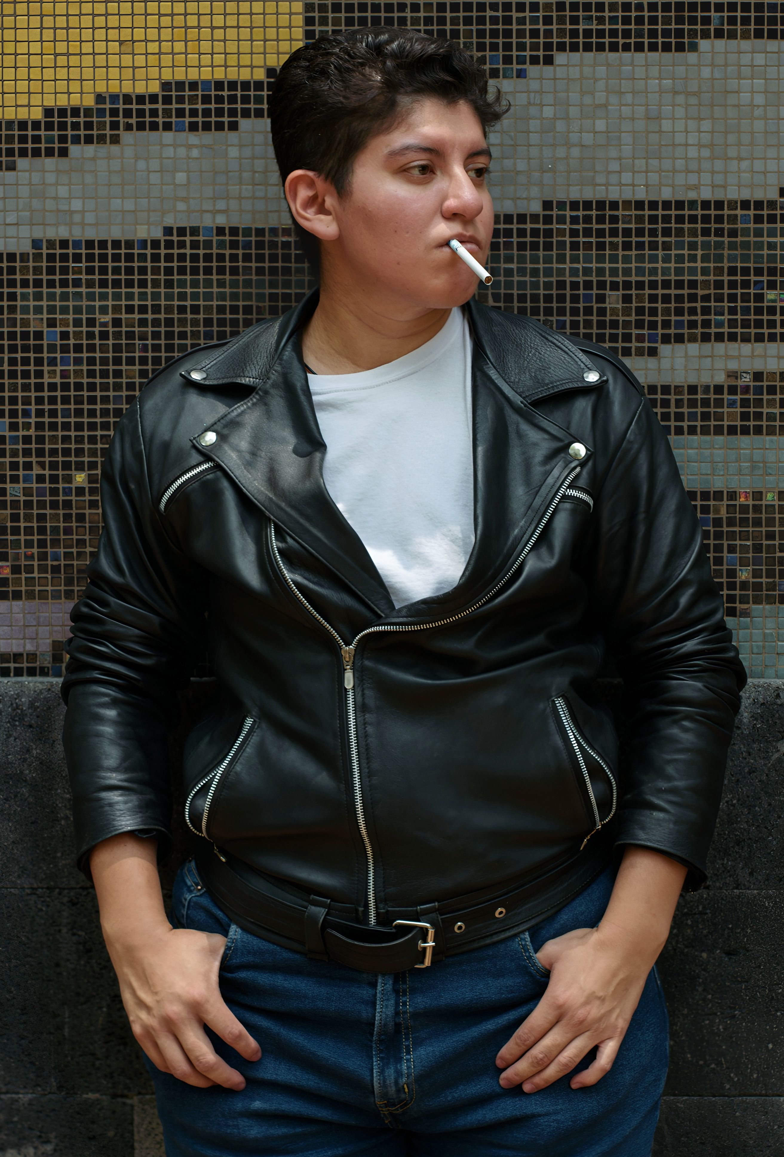 A man in a leather jacket smoking a cigarette · Free Stock Photo