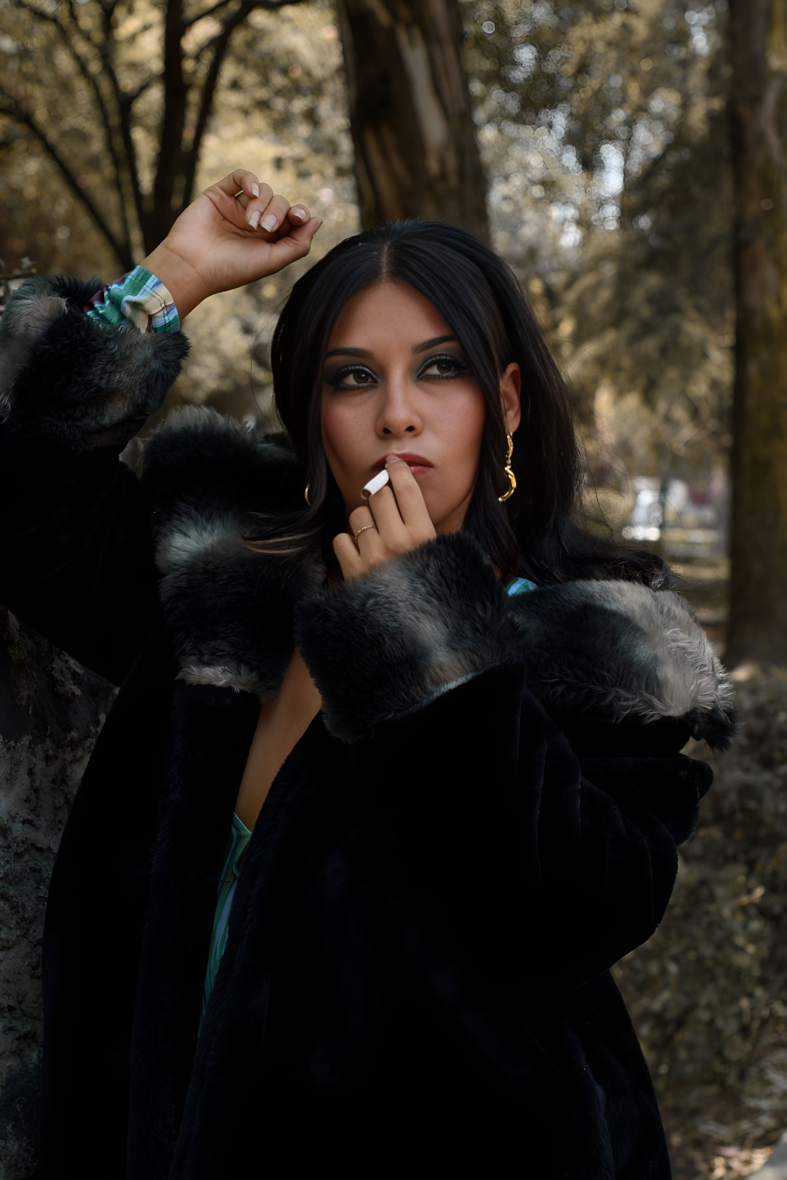 Brunette Woman in Fur Coat Smoking Cigarette in Park · Free Stock Photo
