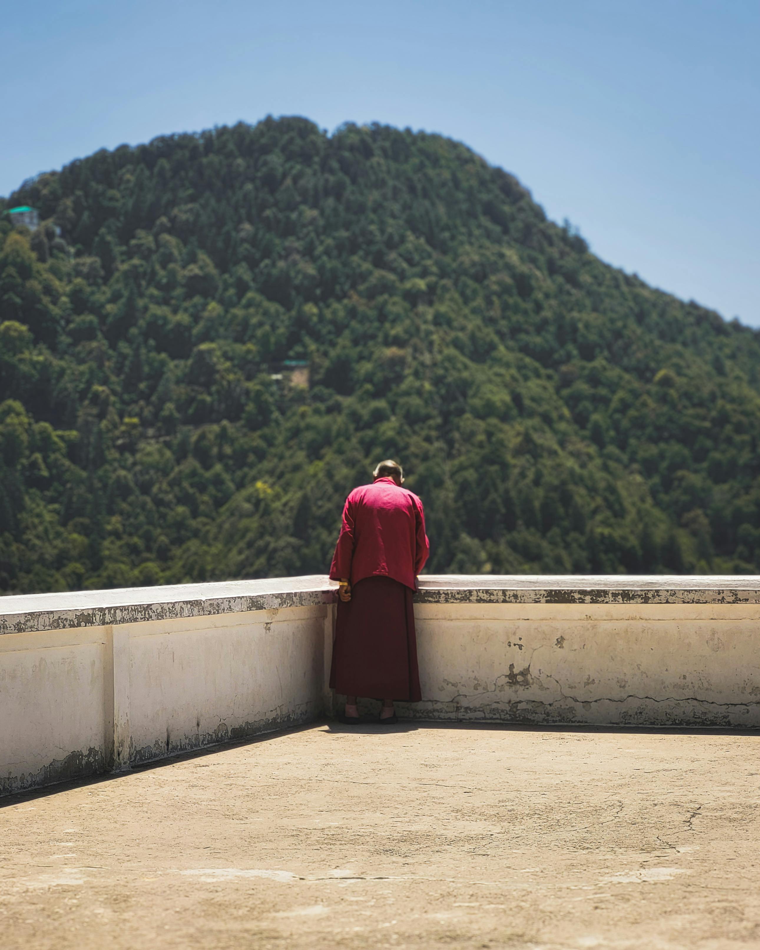 Back View of a Monk Standing on the Terrace with View of a Mountain ...