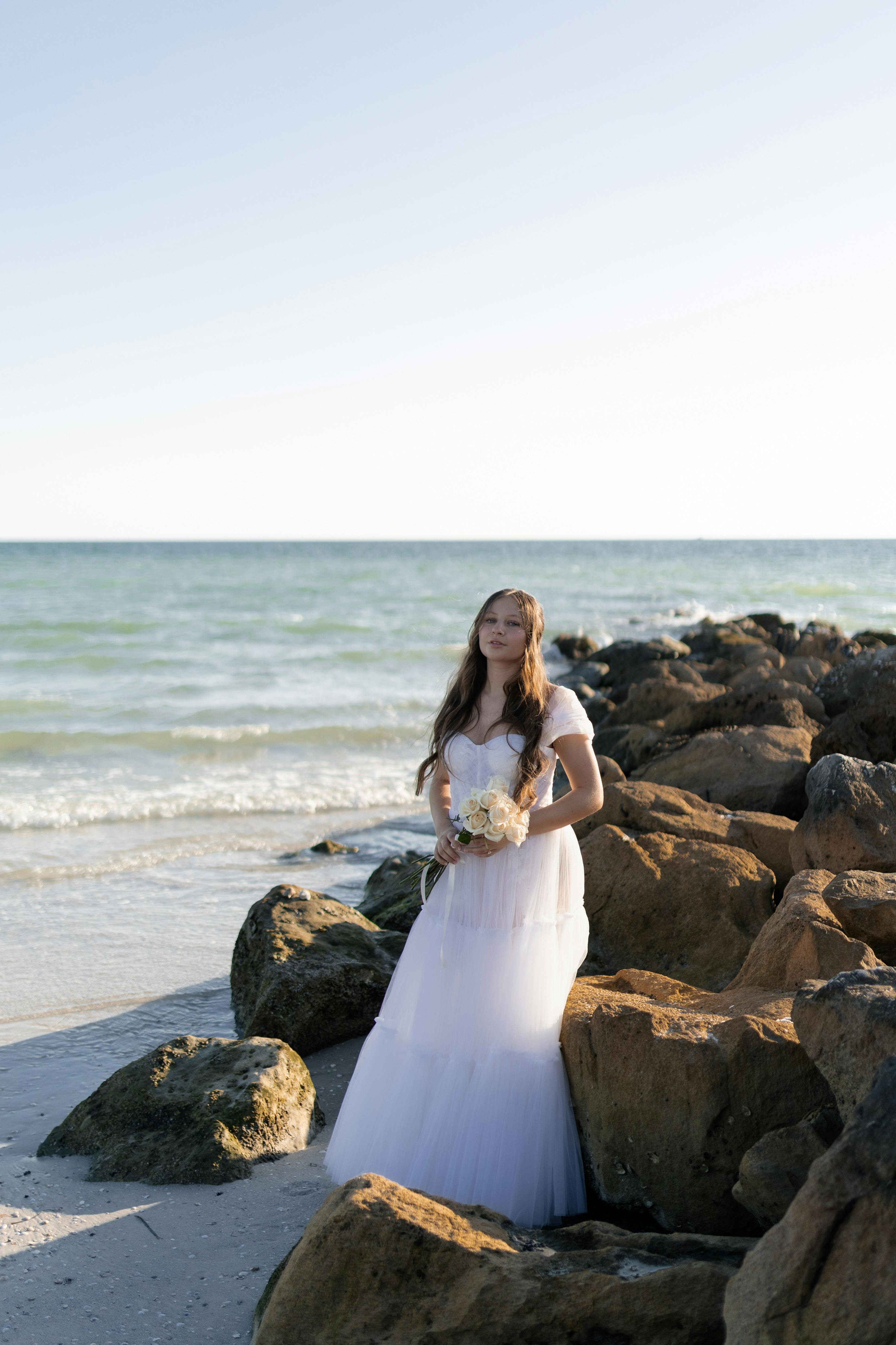 A Bride Posing on the Beach · Free Stock Photo