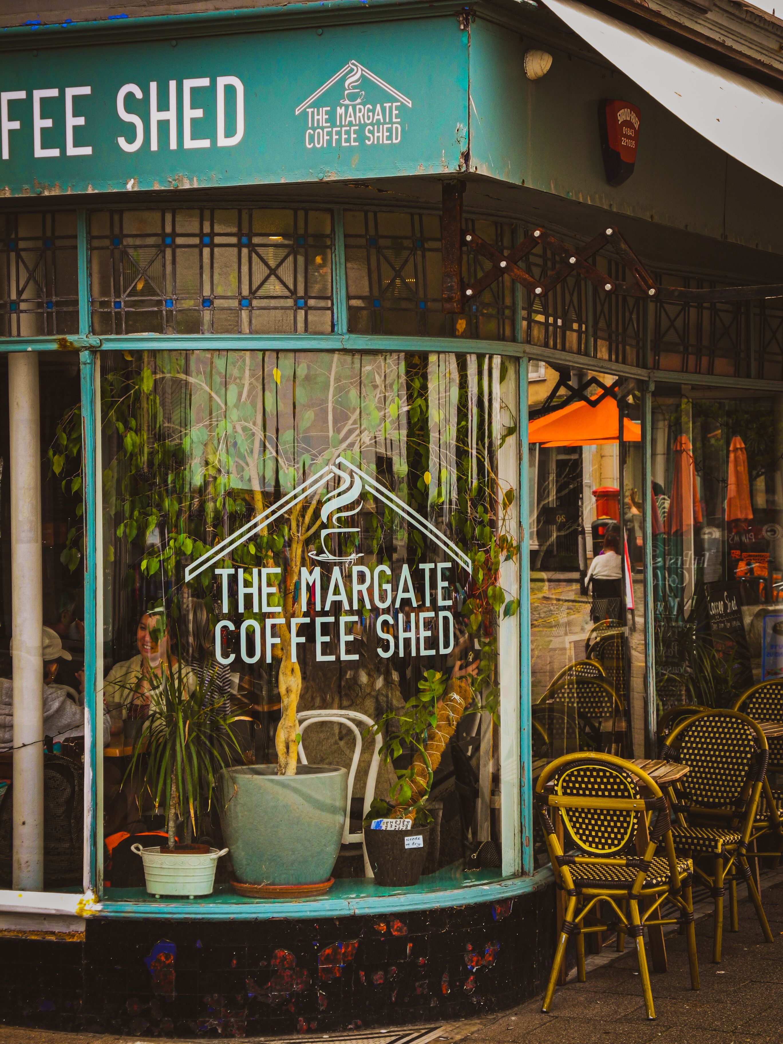 Exterior of historic building with local cafe · Free Stock Photo