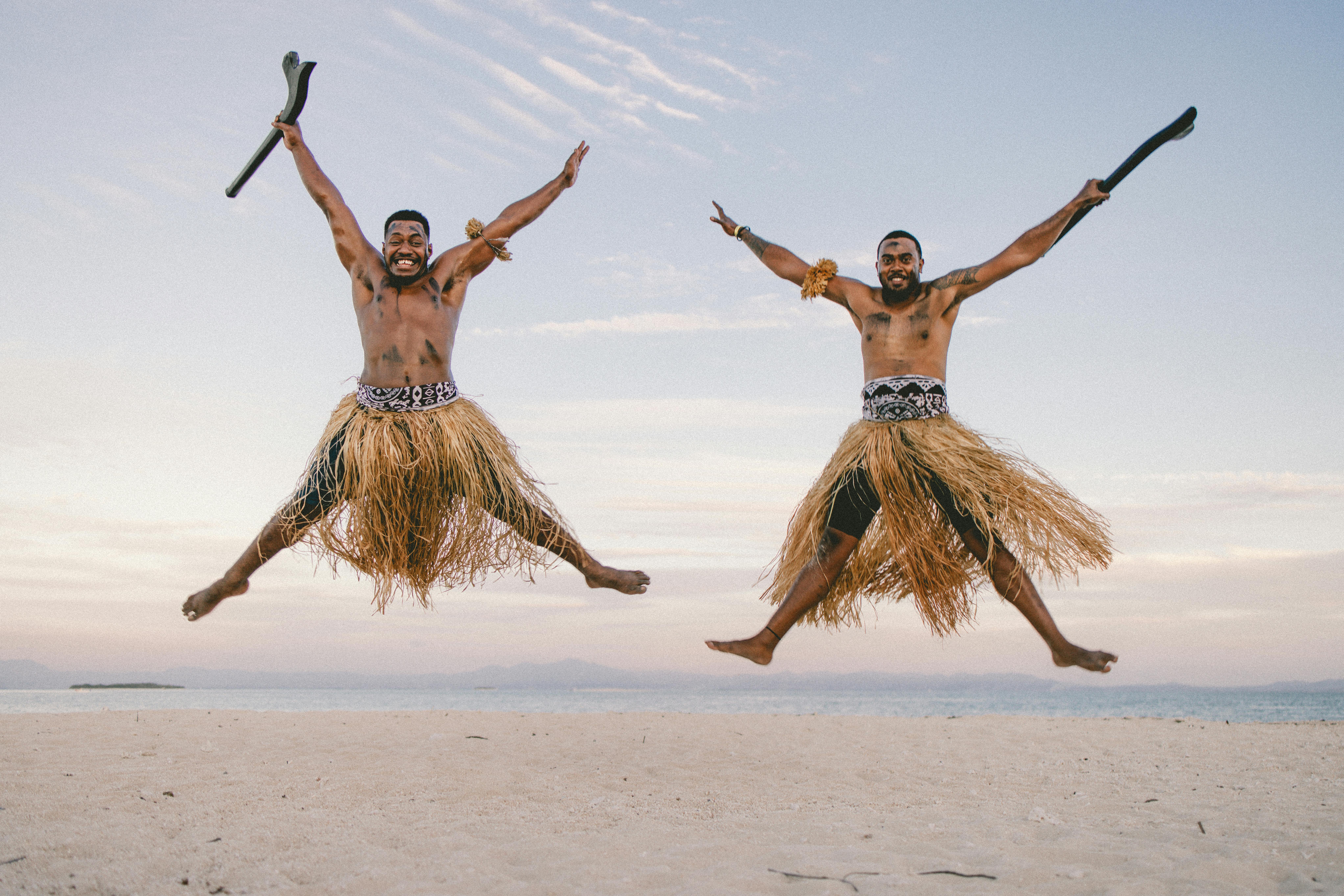 Two Men Jumping Happily on a Beach · Free Stock Photo