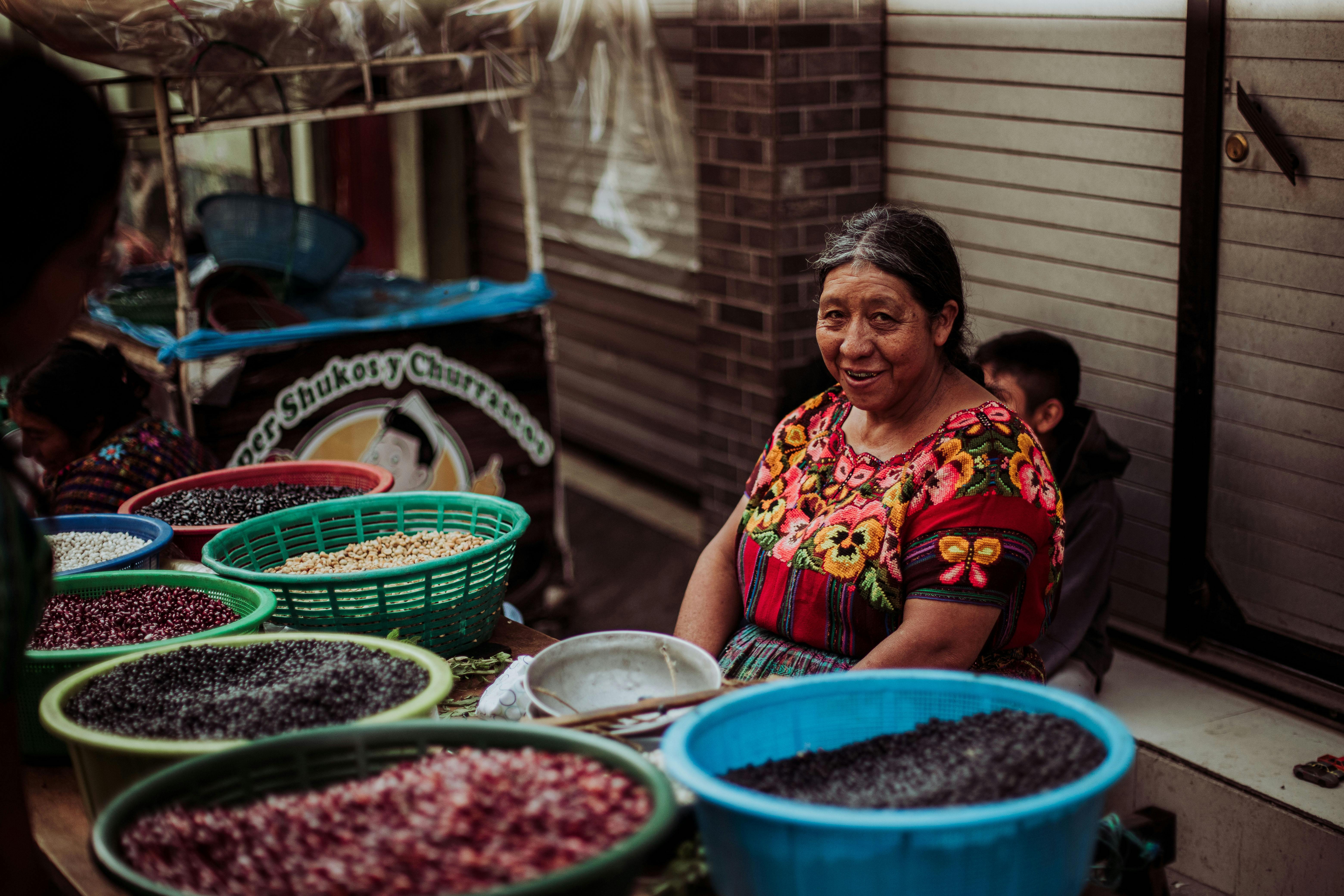 Smiling Merchant in Market · Free Stock Photo