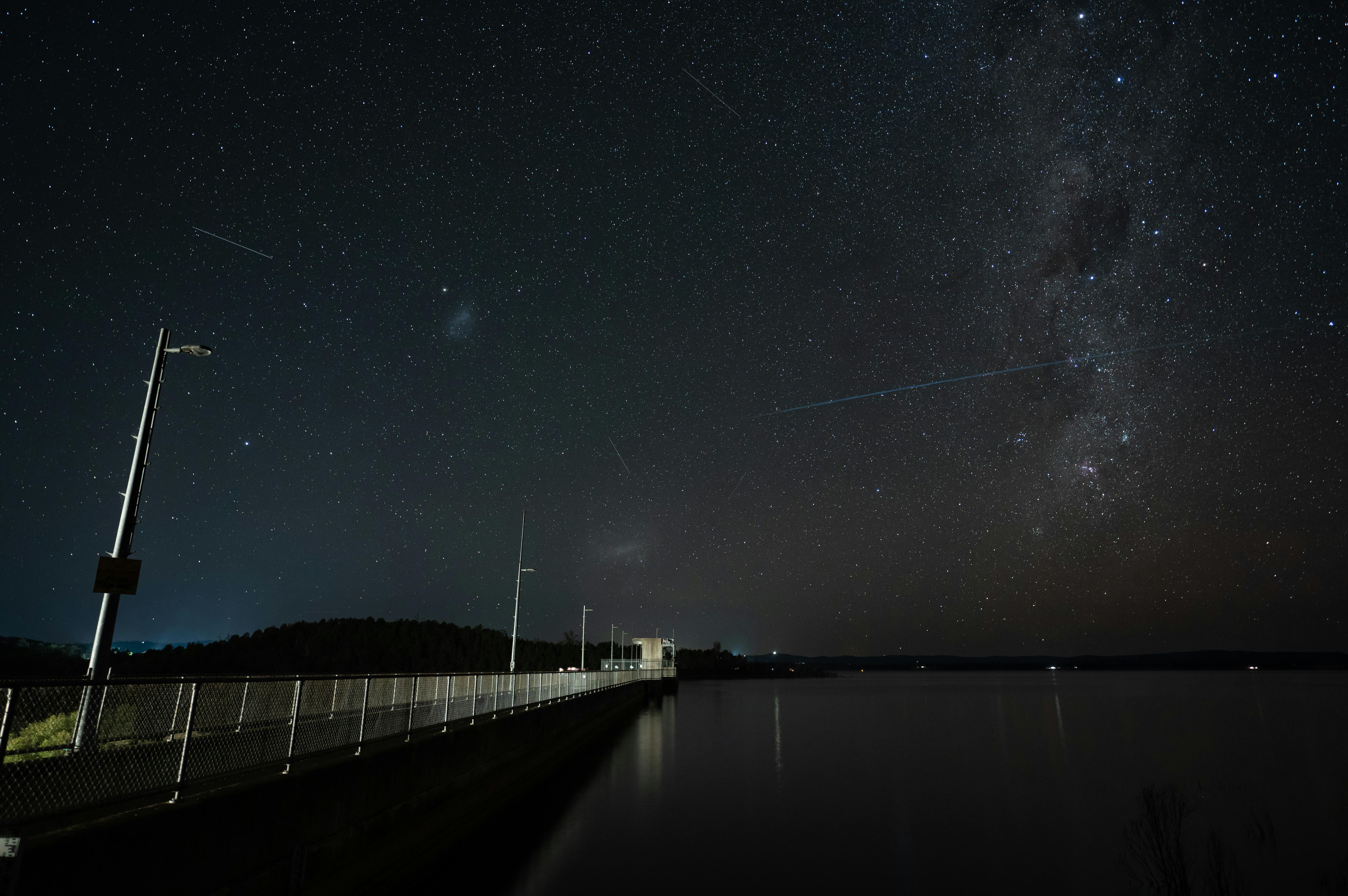Stars on Night Sky over Pier and Lake · Free Stock Photo