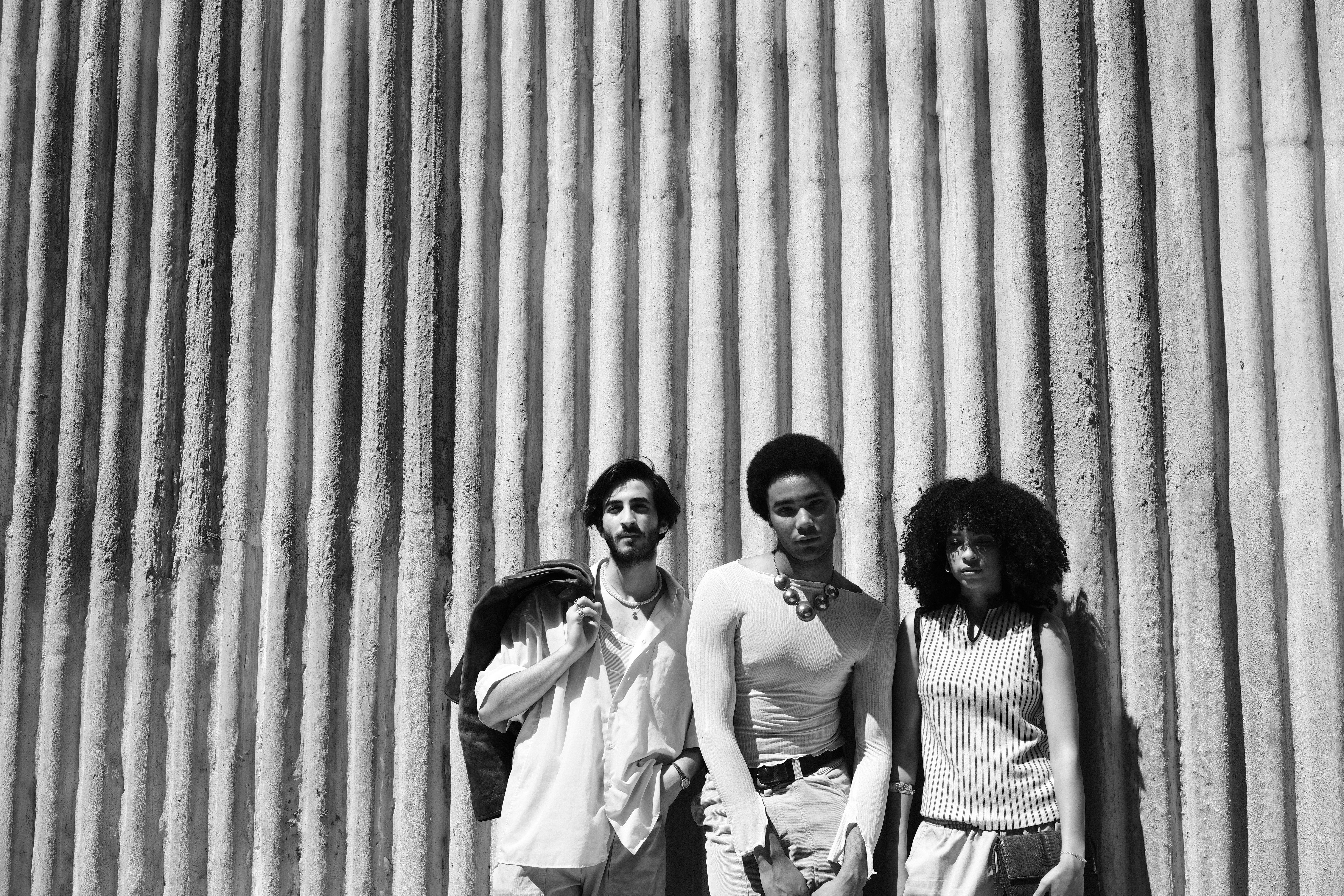 A Group Standing by a Wall · Free Stock Photo