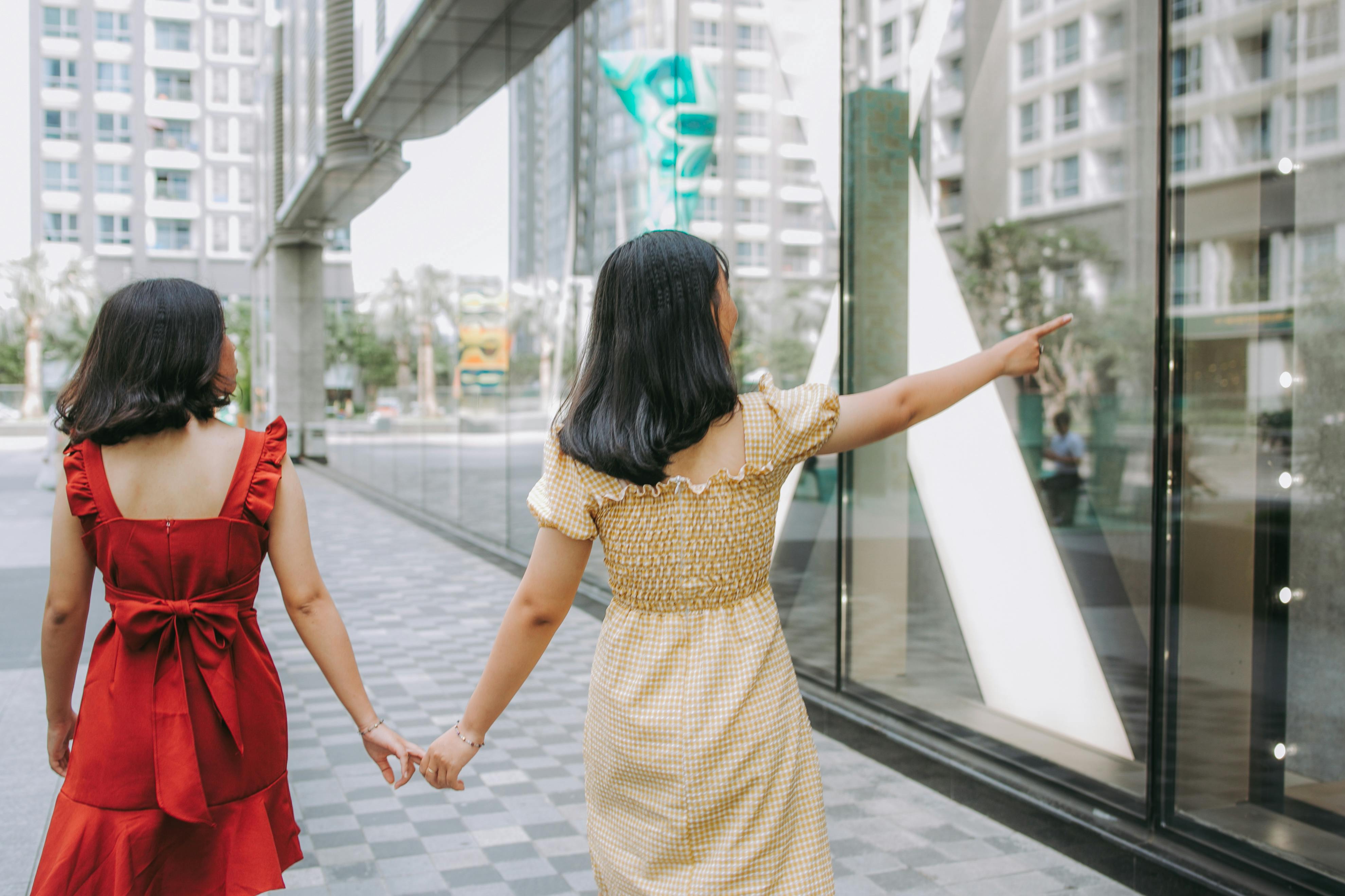 Photo of Two Women Holding Hands While Walking · Free Stock Photo