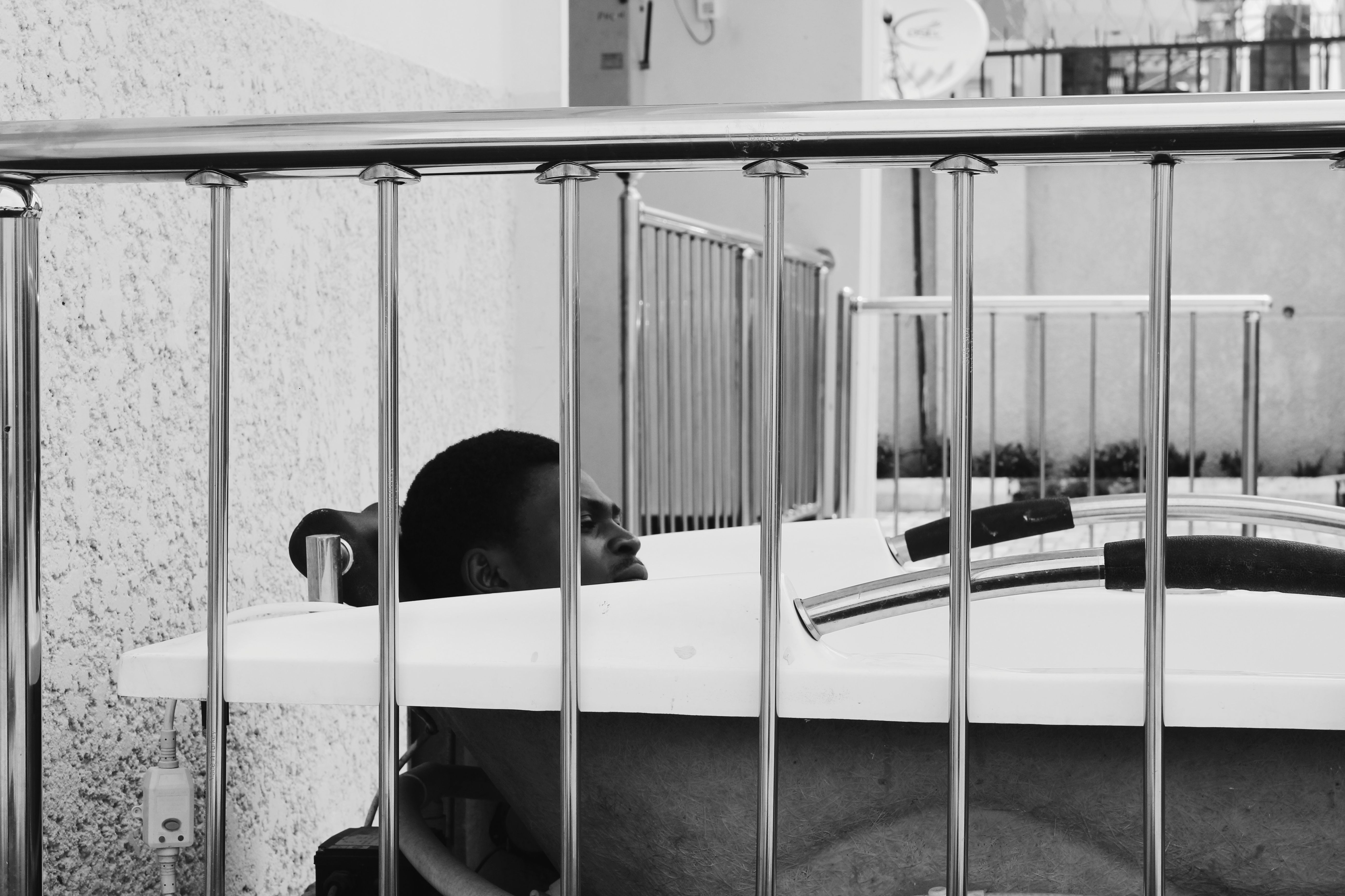 Man on Balcony in Black and White · Free Stock Photo