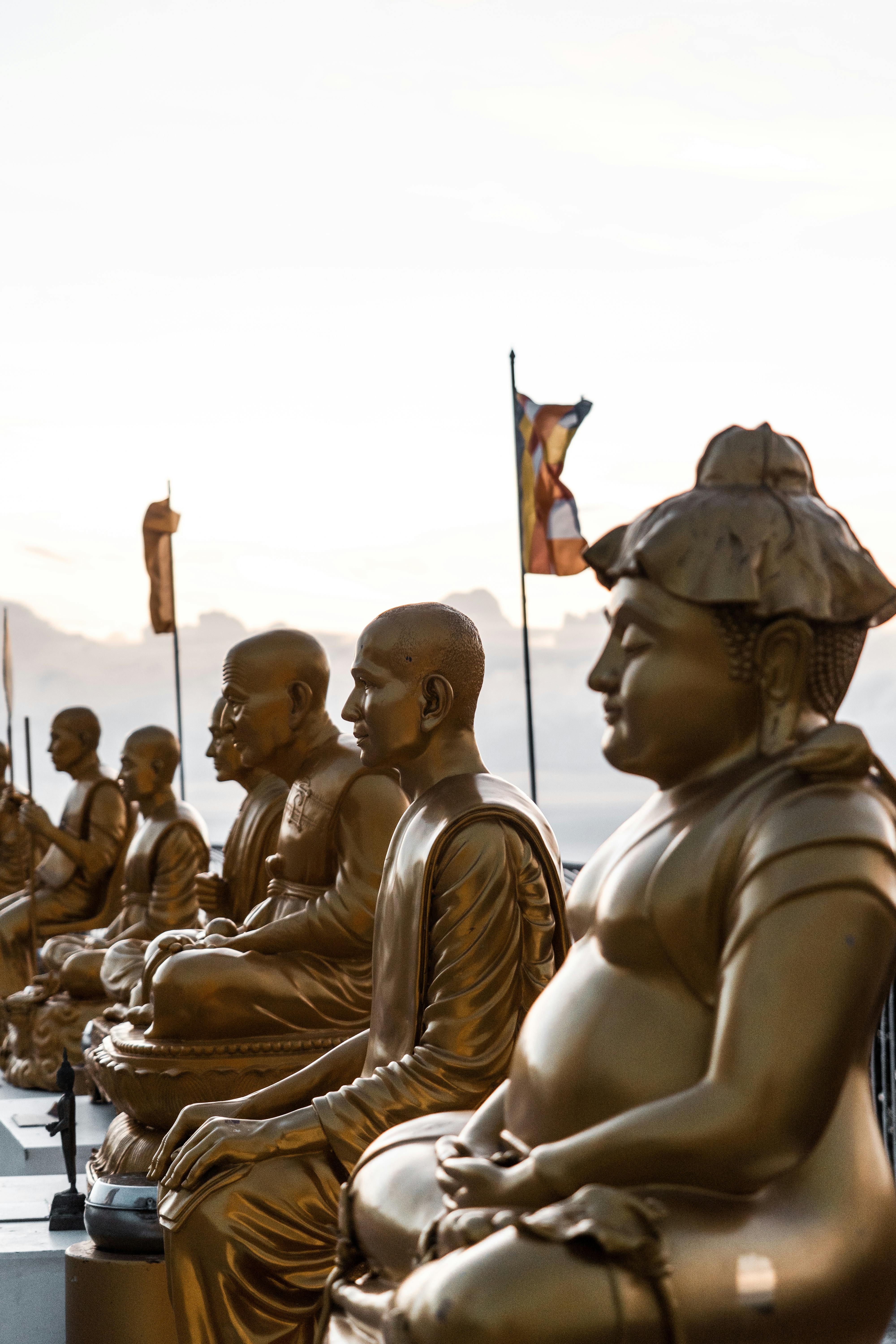 Row of Bronze Statues Depicting Meditating Buddhist Monks · Free Stock ...