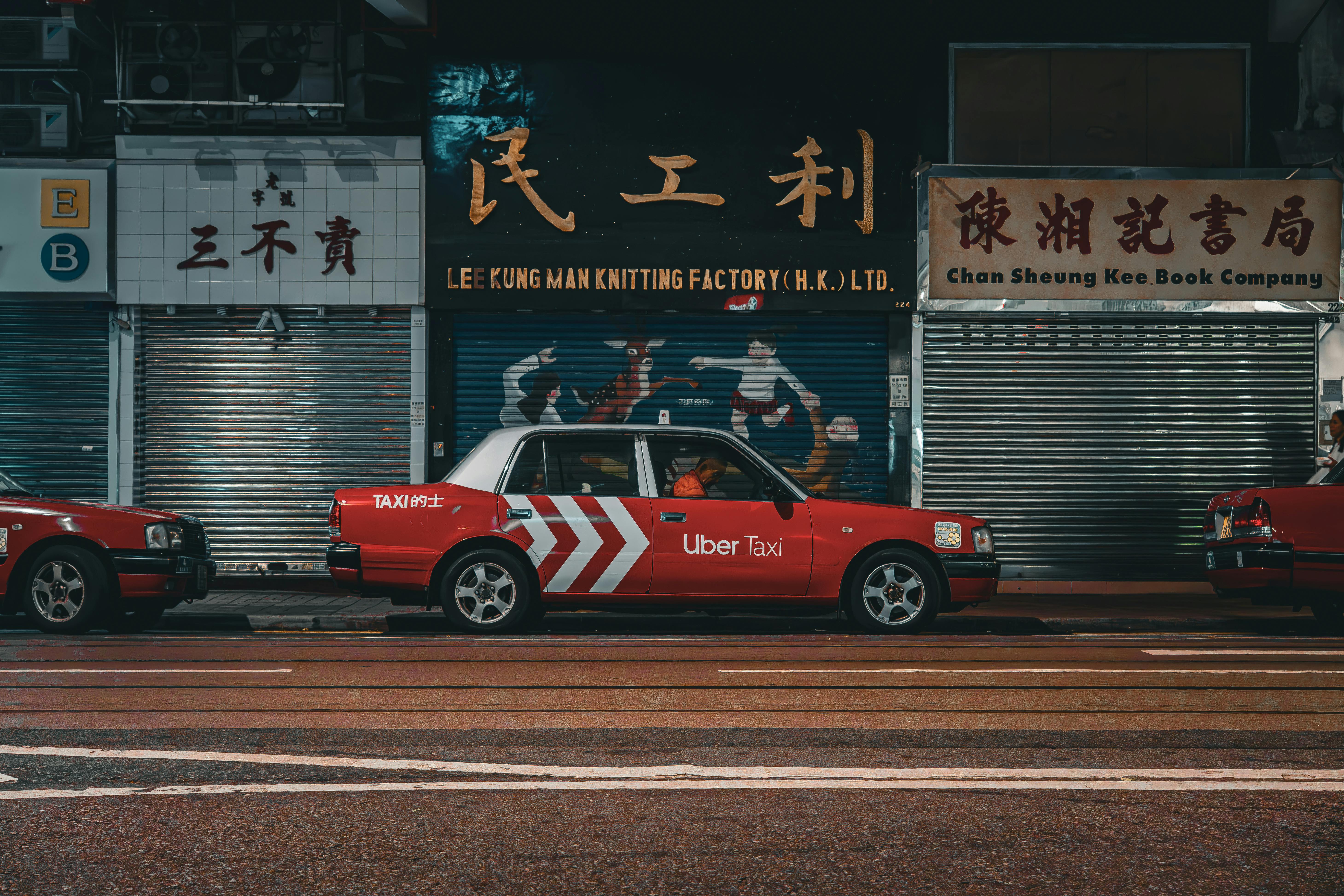 Red Taxi Parked on the Side of a Road in Hong Kong · Free Stock Photo