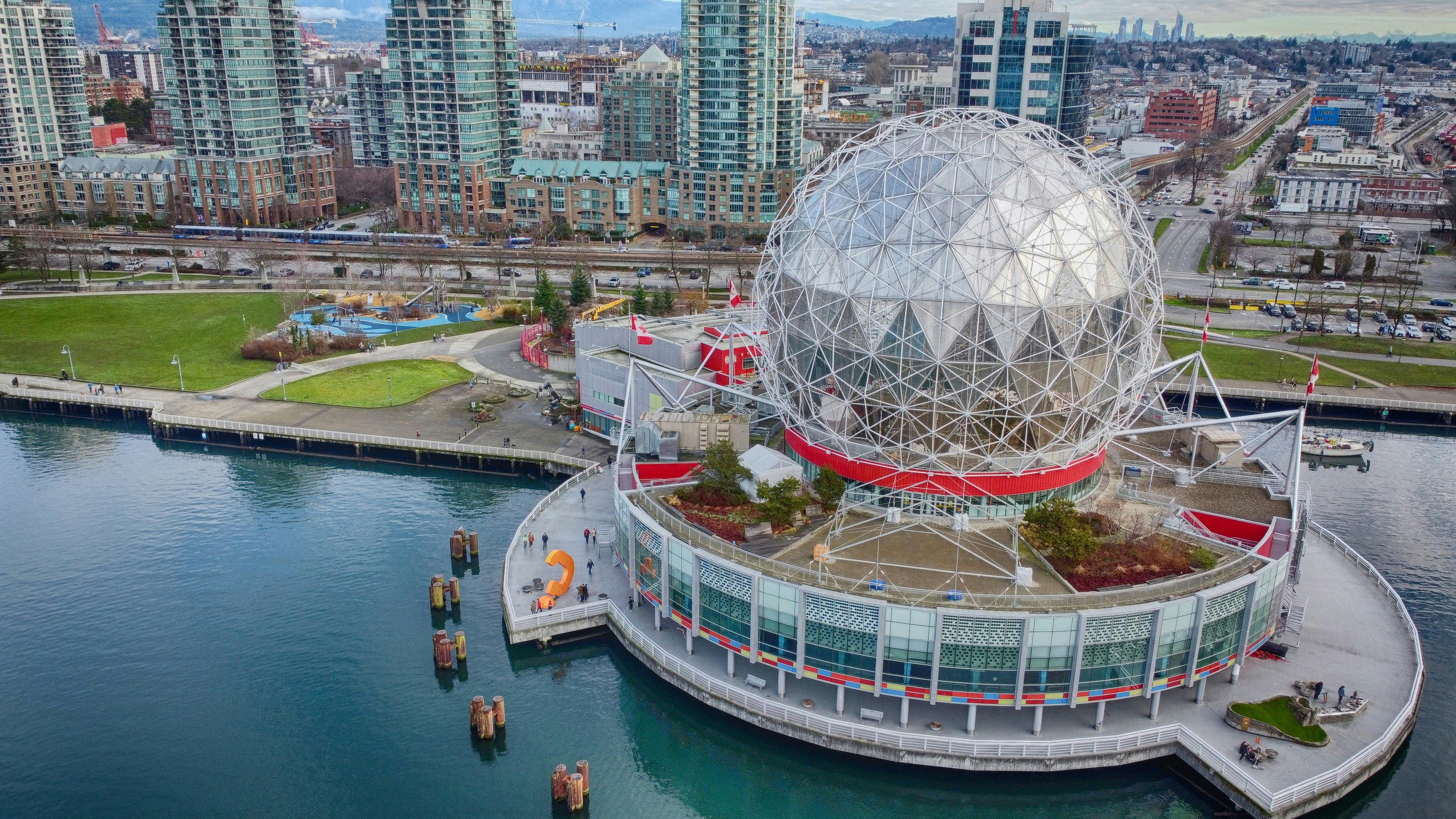 Science World in Vancouver surround by turquoise water of False Creek ...