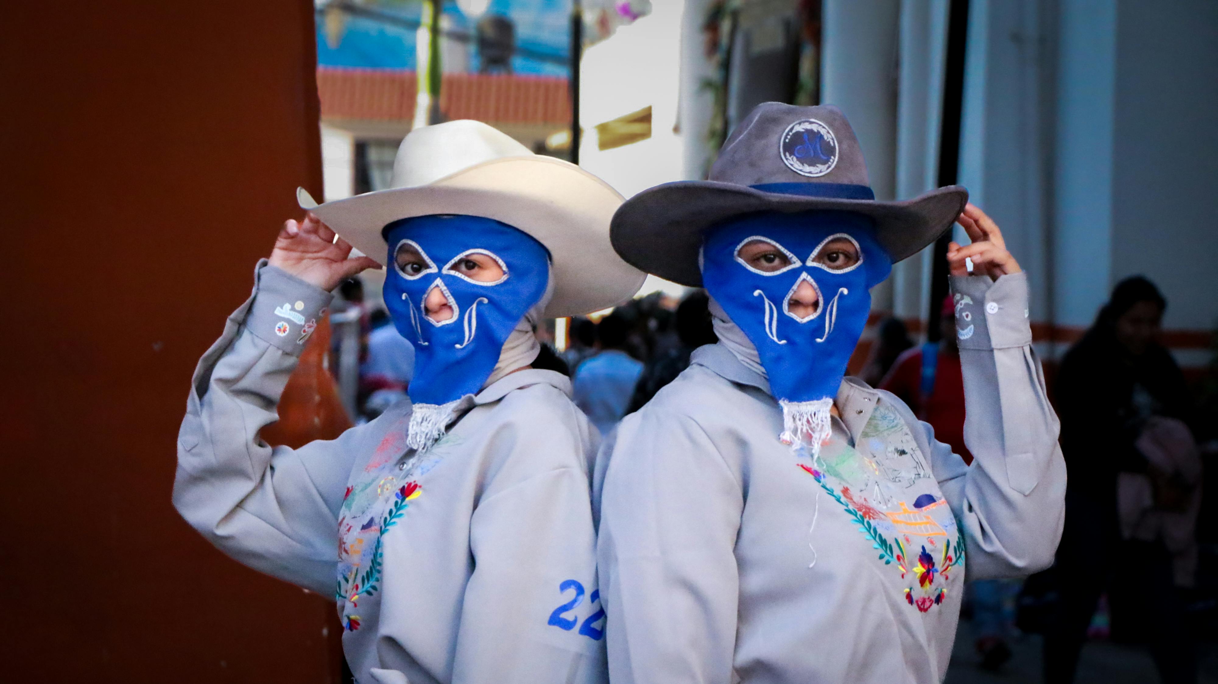 Performers in Cowboy Hats and Masks · Free Stock Photo