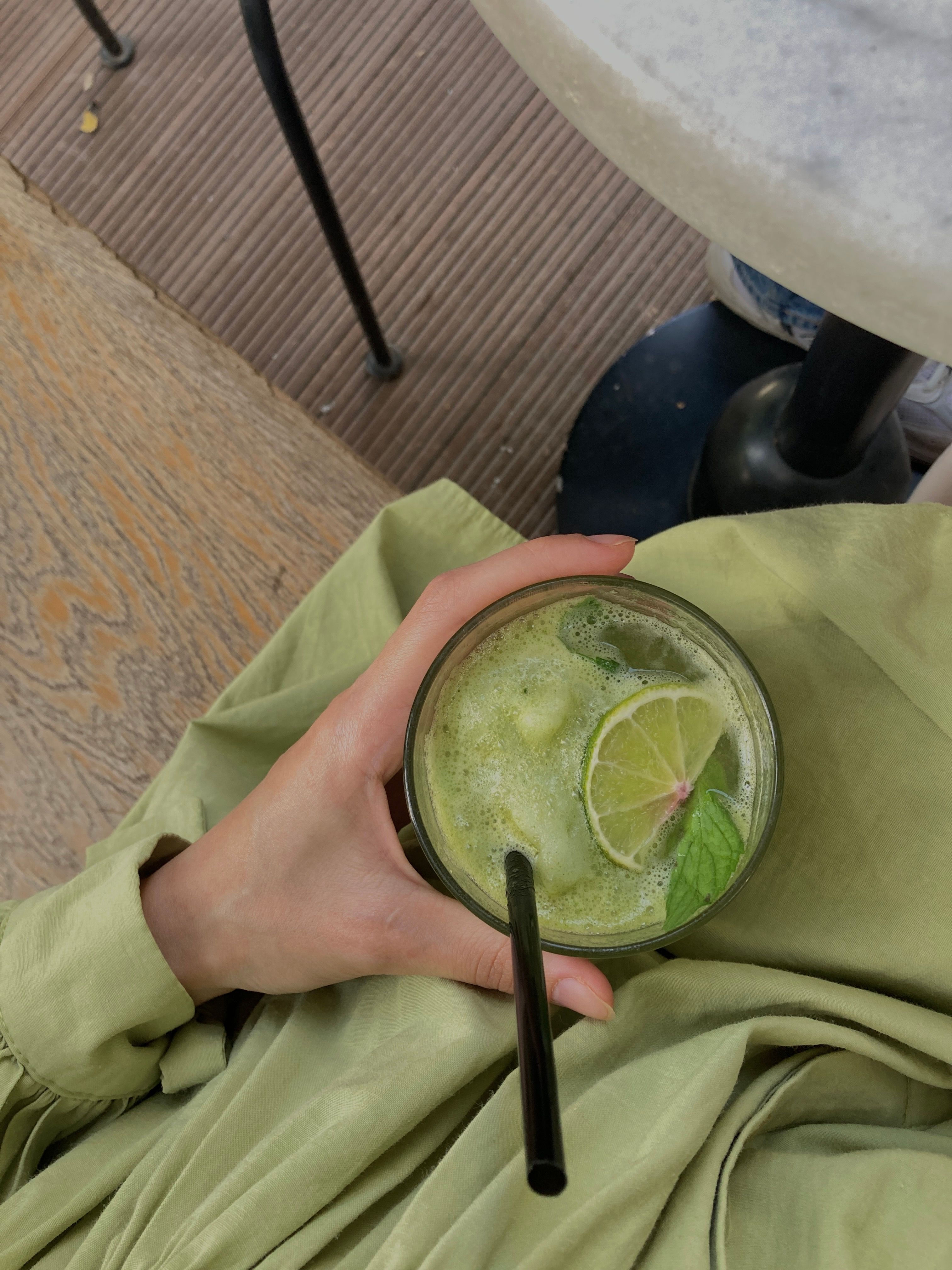 A person holding a drink with lime and mint · Free Stock Photo