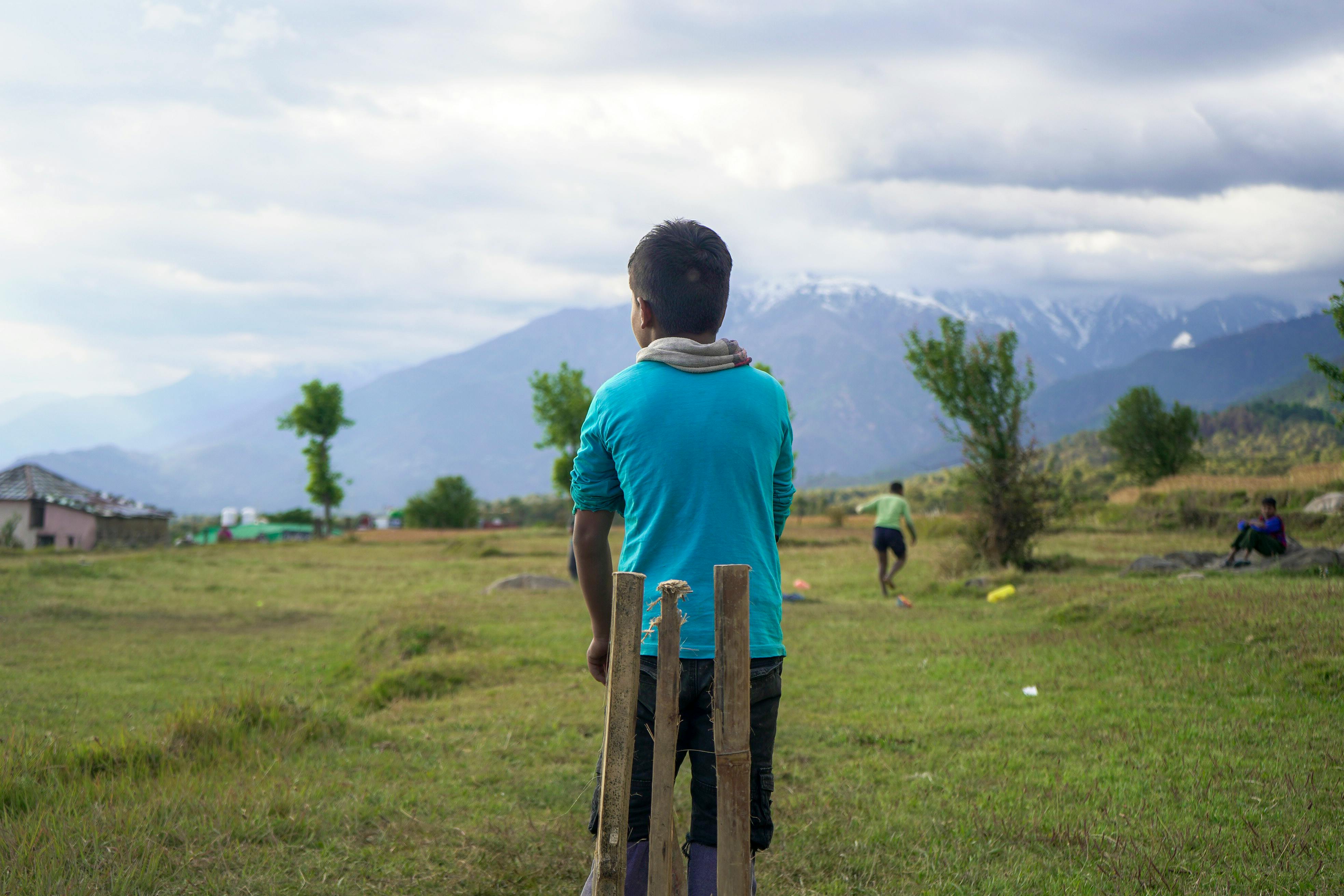 Back View of a Boy Looking at the Mountains · Free Stock Photo