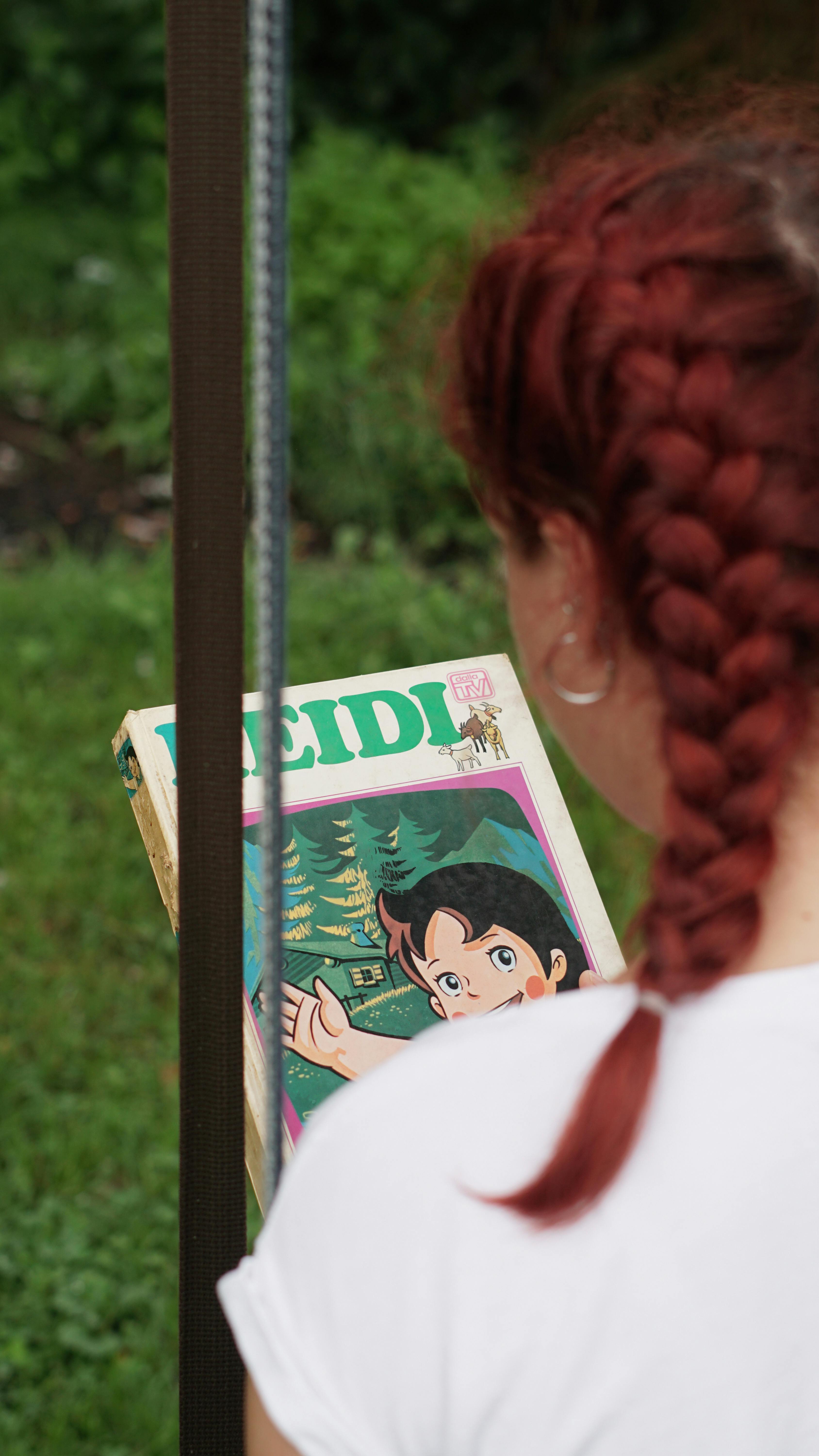 A woman with red hair reading a book · Free Stock Photo