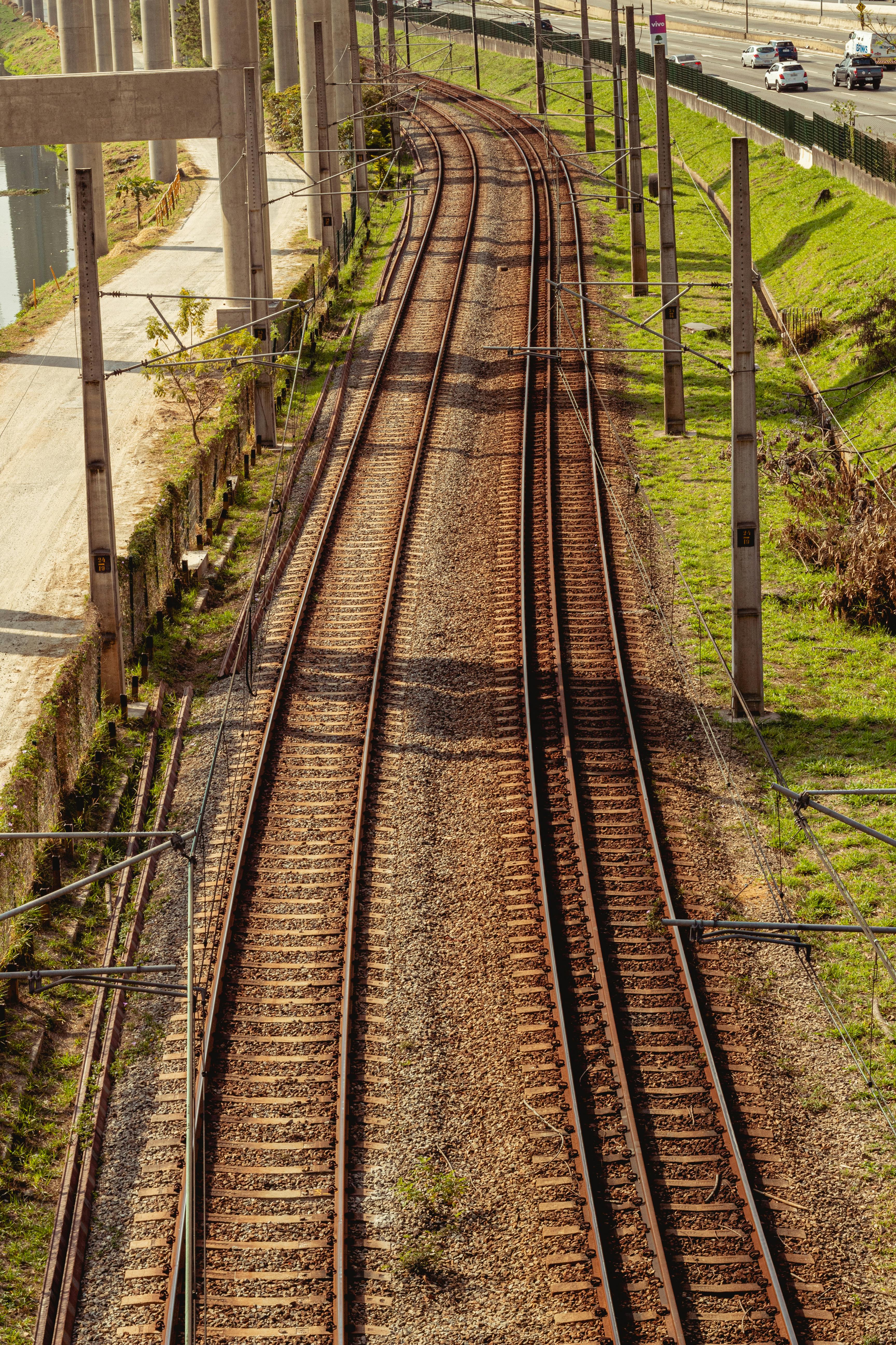 Grayscale Photography of Train Rail Between Buildings · Free Stock Photo