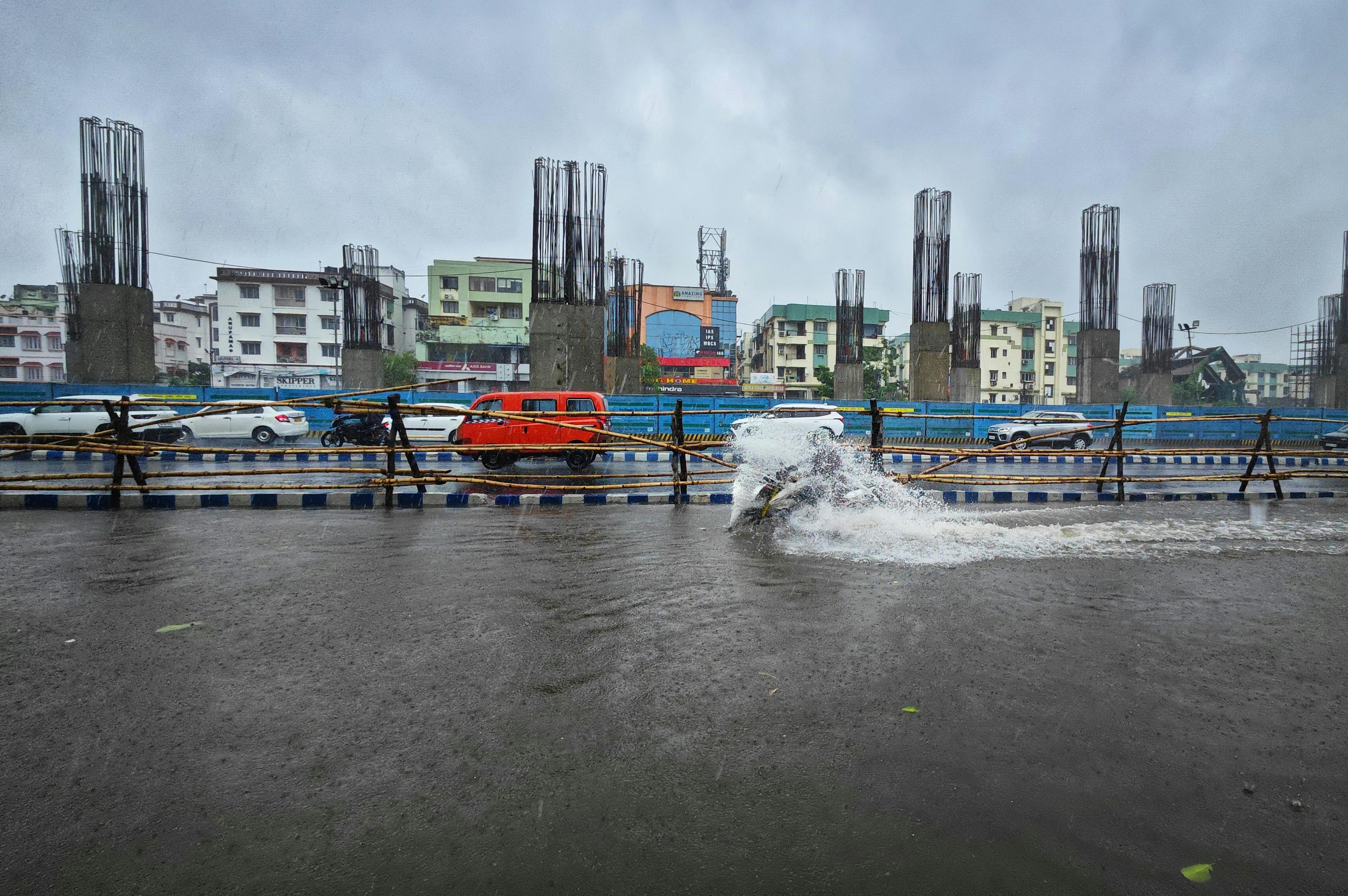 Man Dragging a Motorcycle Through the Flooding · Free Stock Photo