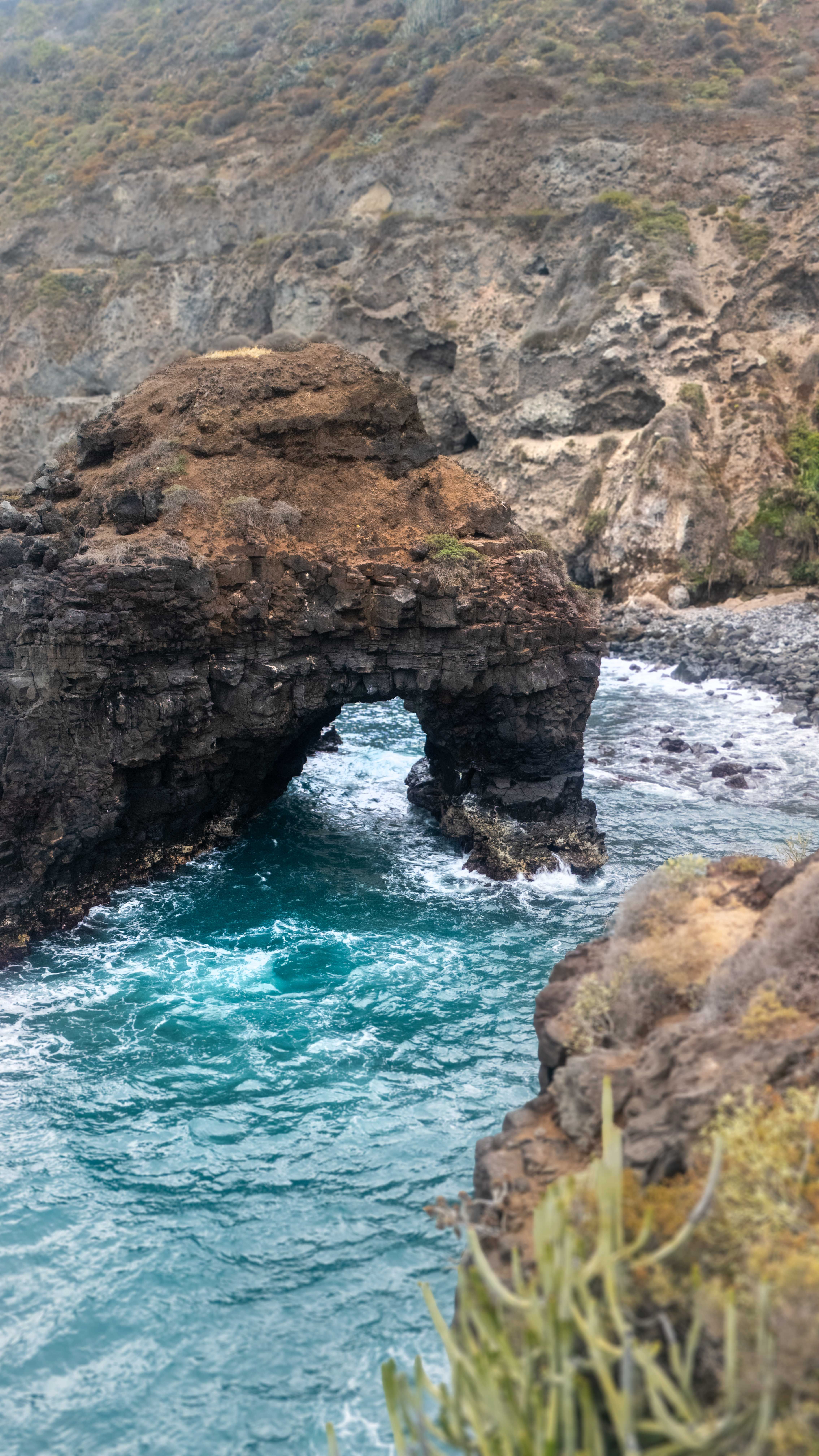 View of a Rock Arch on the Ocean Coast · Free Stock Photo
