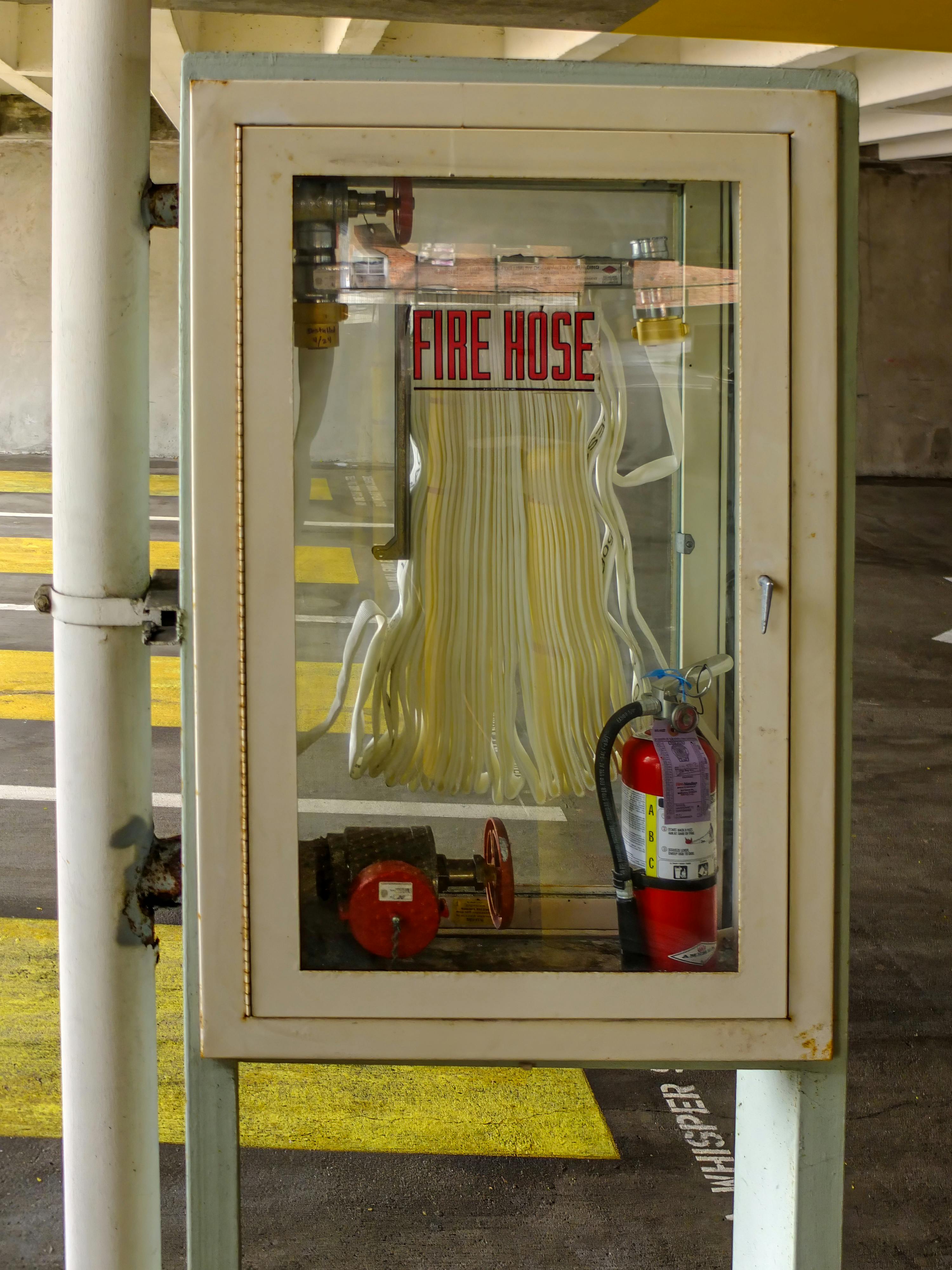 A fire hose is displayed in a fire box · Free Stock Photo