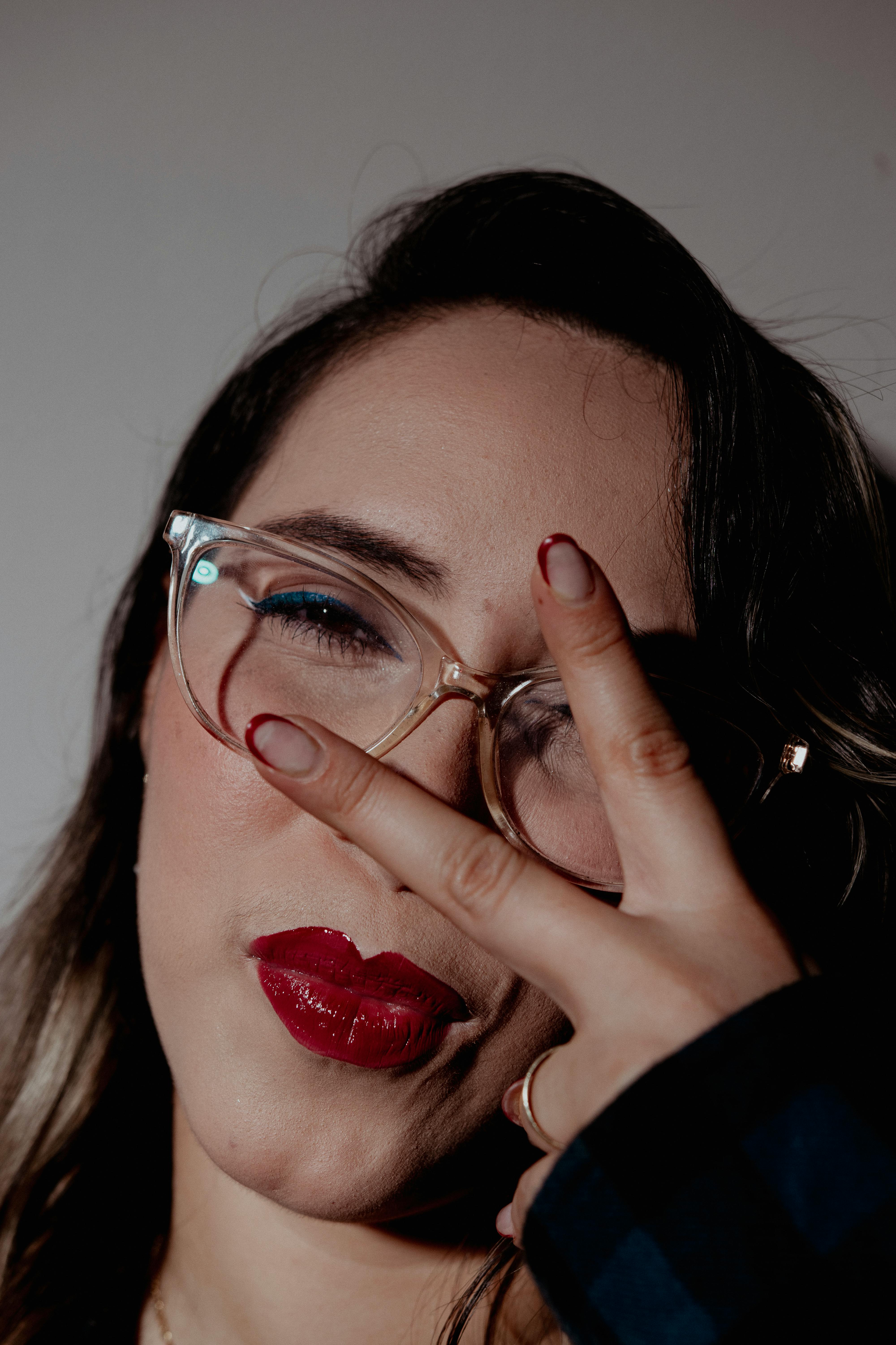 Woman Showing V Sign over Face · Free Stock Photo