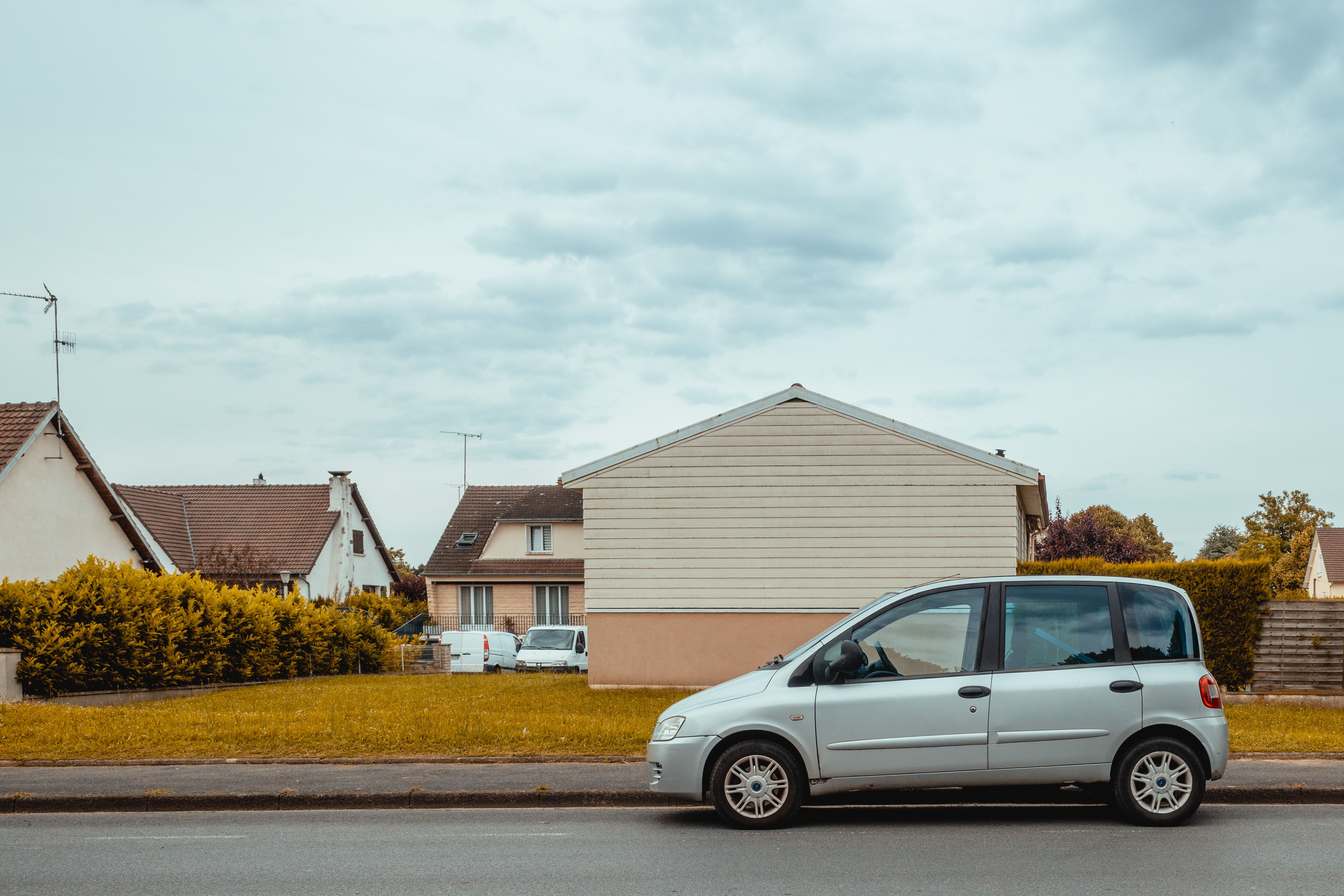 A Car Parked on the Suburb Street · Free Stock Photo