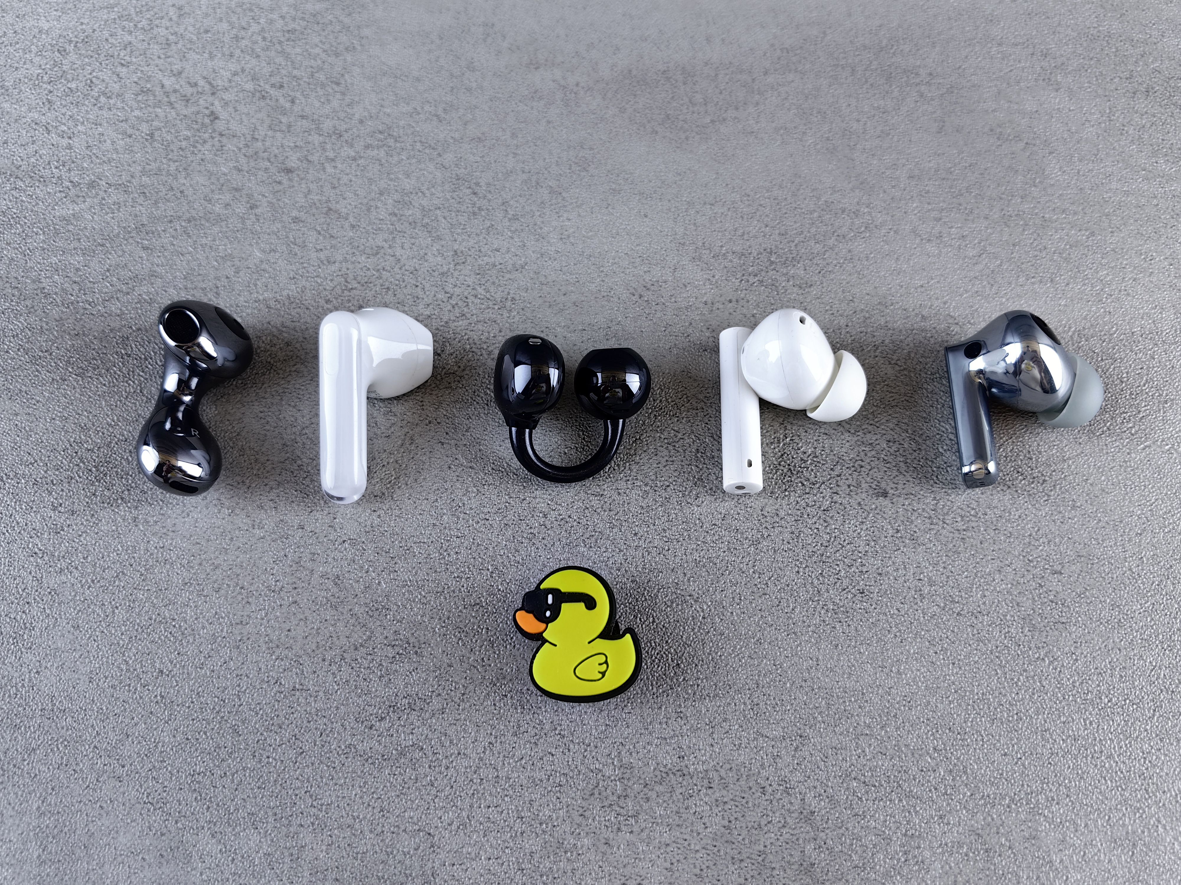 A group of four white and black earphones with a rubber duck · Free ...