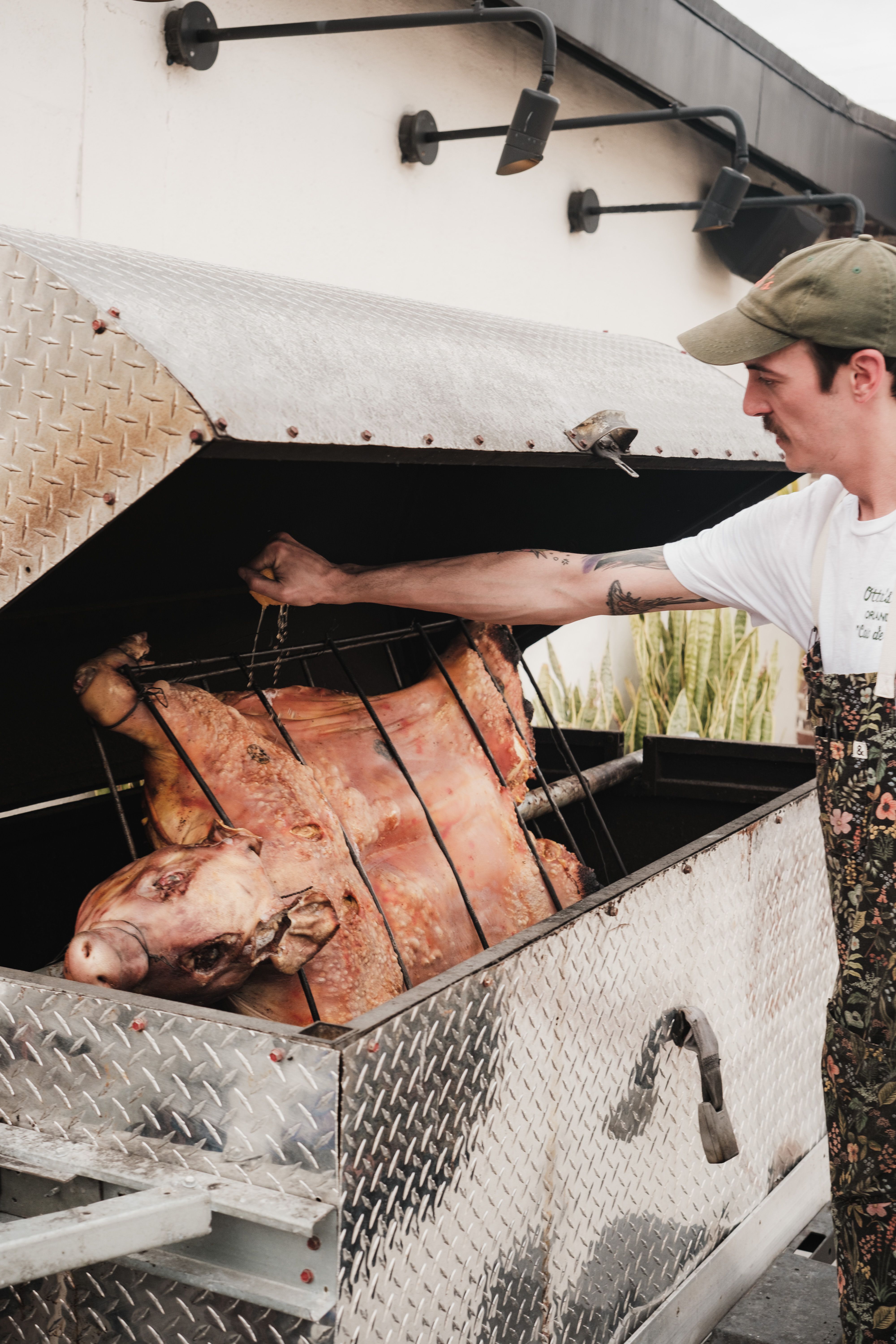 Man Roasting Pork Meat on Barbecue · Free Stock Photo