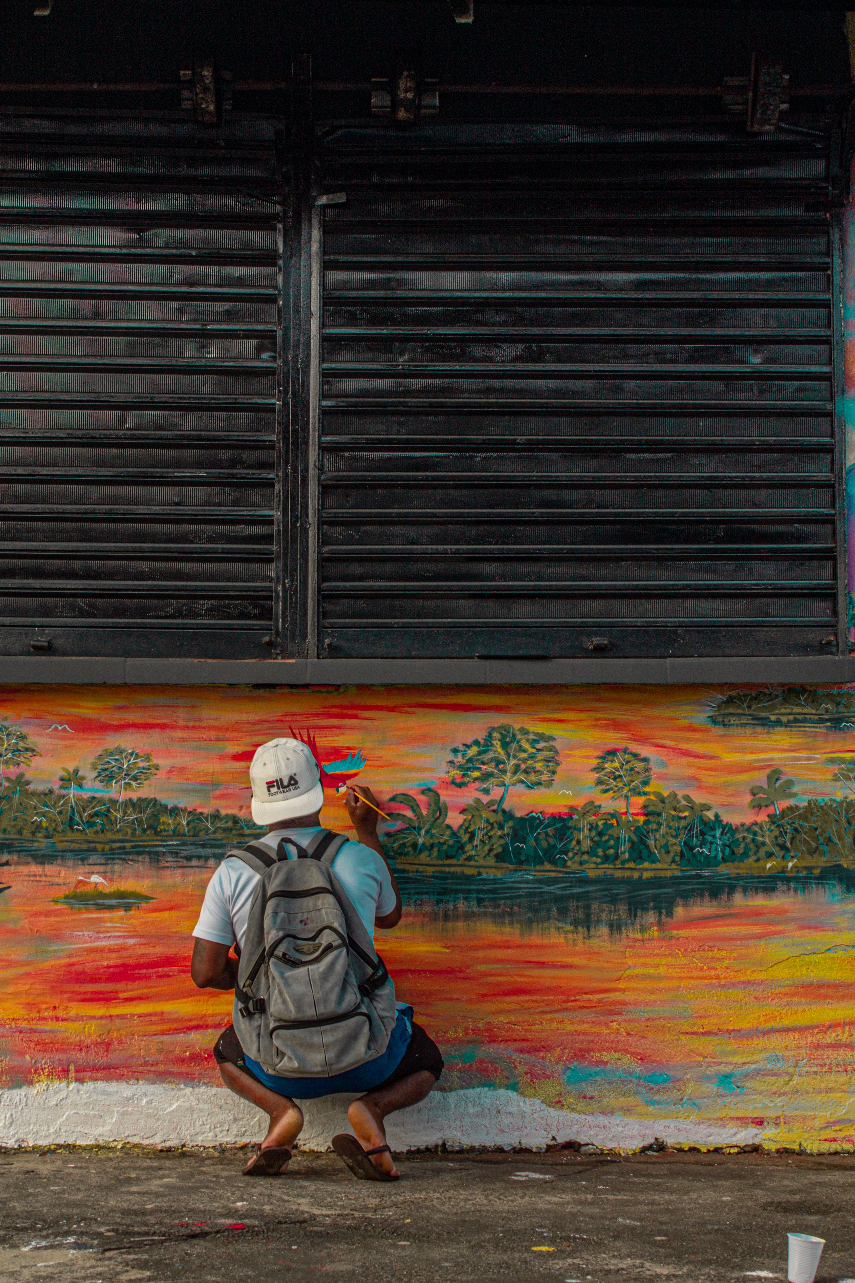 Back View of a Man Painting a Mural · Free Stock Photo