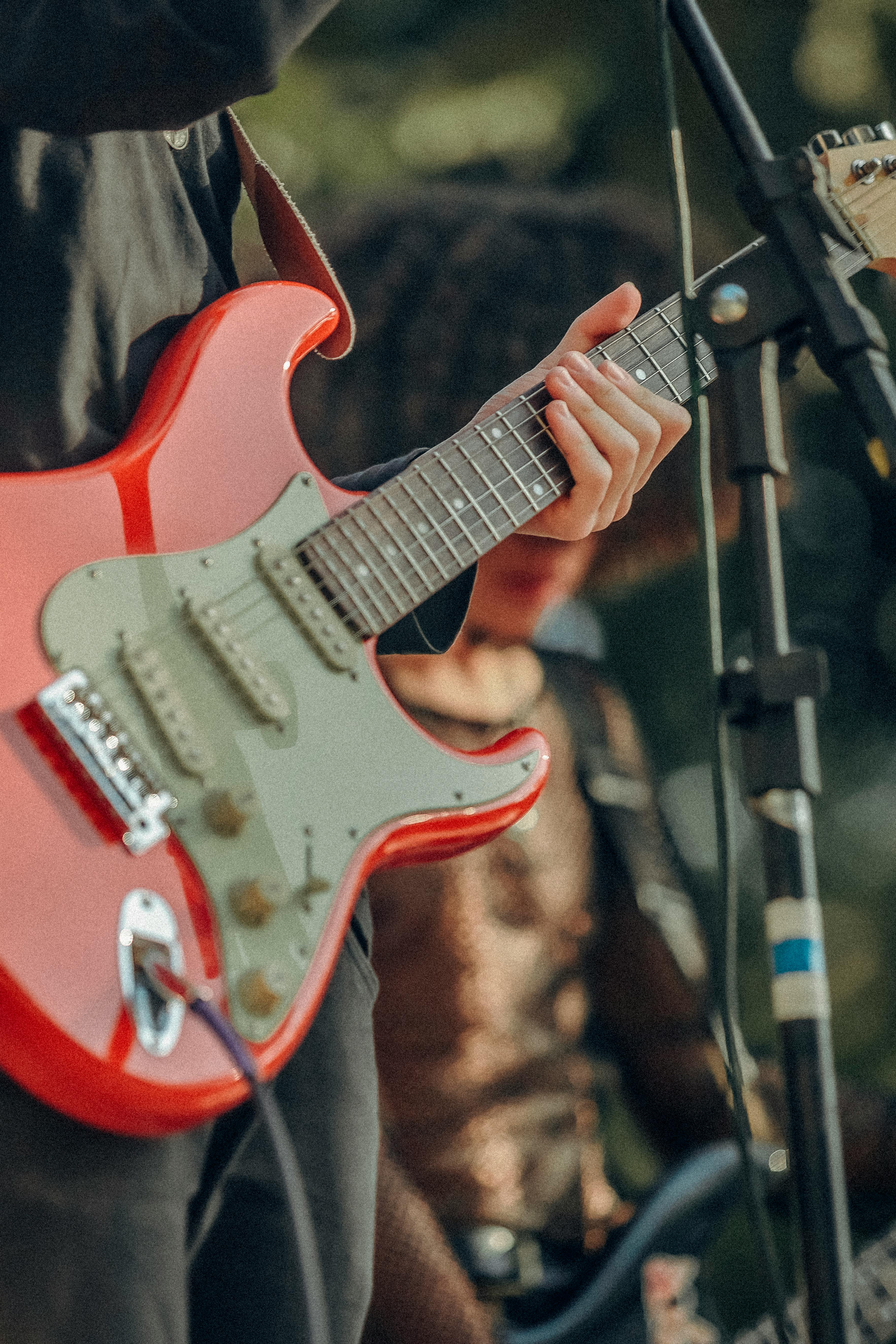 Hand Playing Red Electric Gui · Free Stock Photo